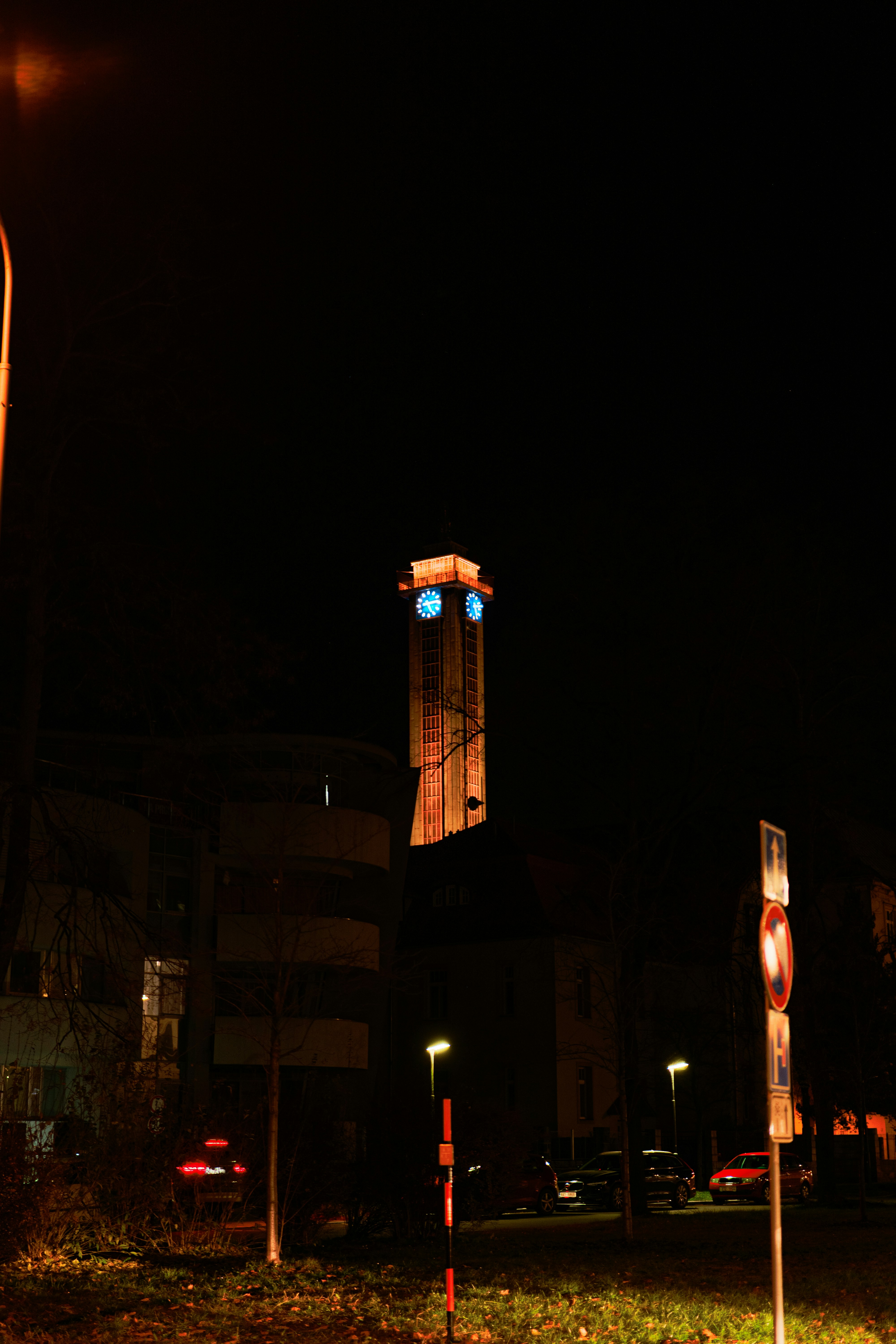 Clocktower at Night: Blue Faces Lighting a Quiet Campus Square