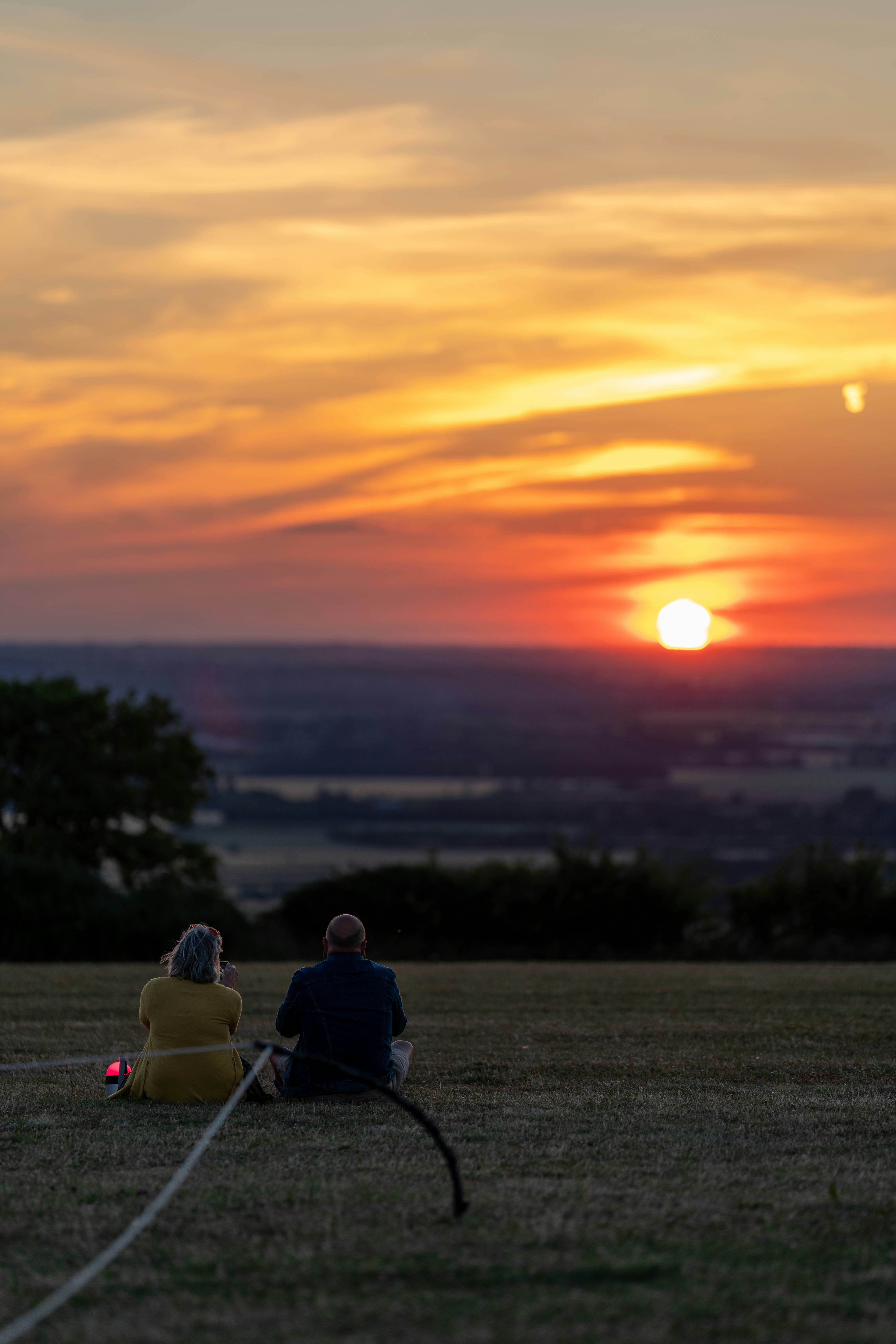 Sunset on the Hill: Two Figures, One Glowing Horizon