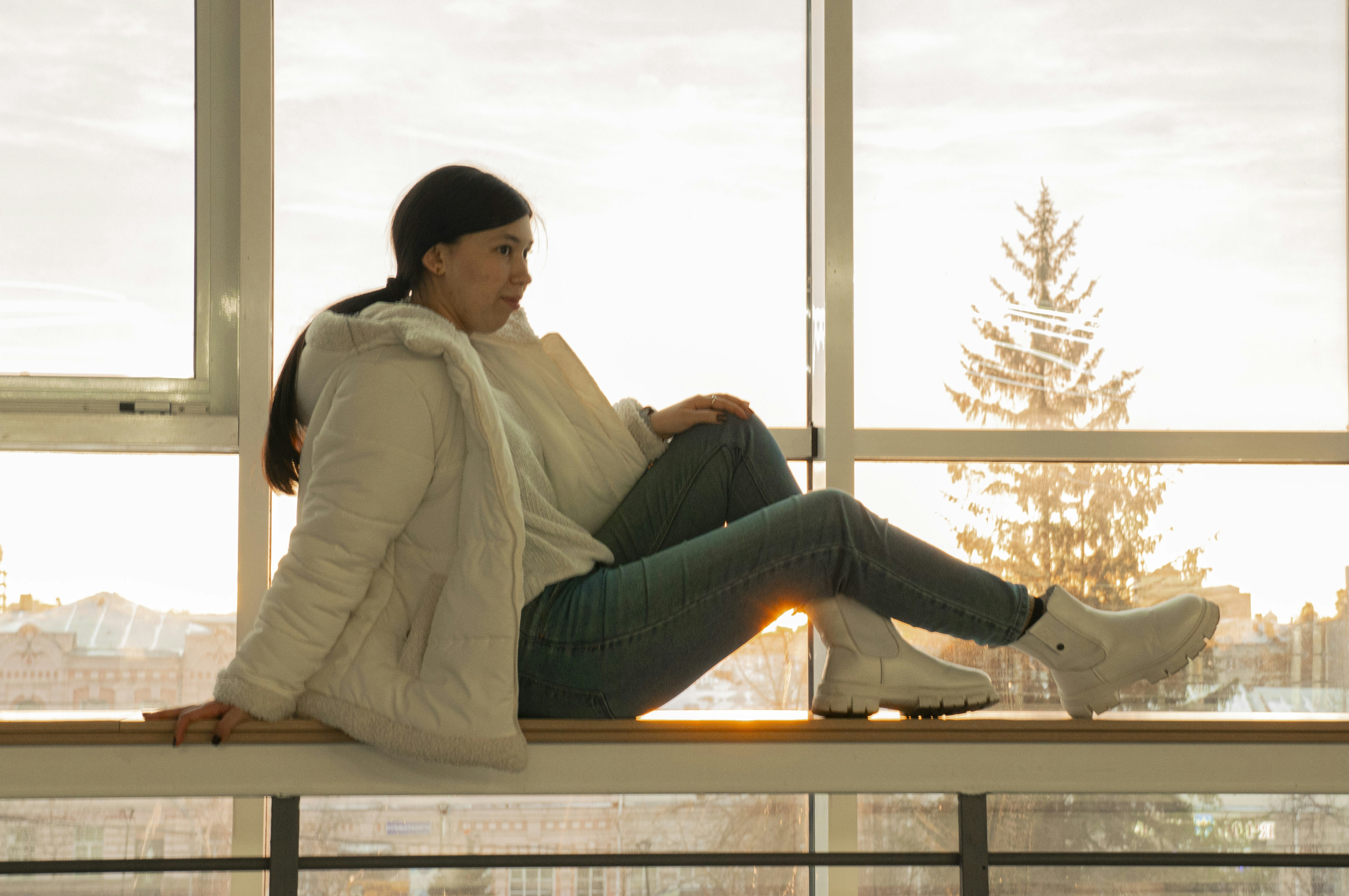 Sunlit Contemplation on a Windowsill Bench
