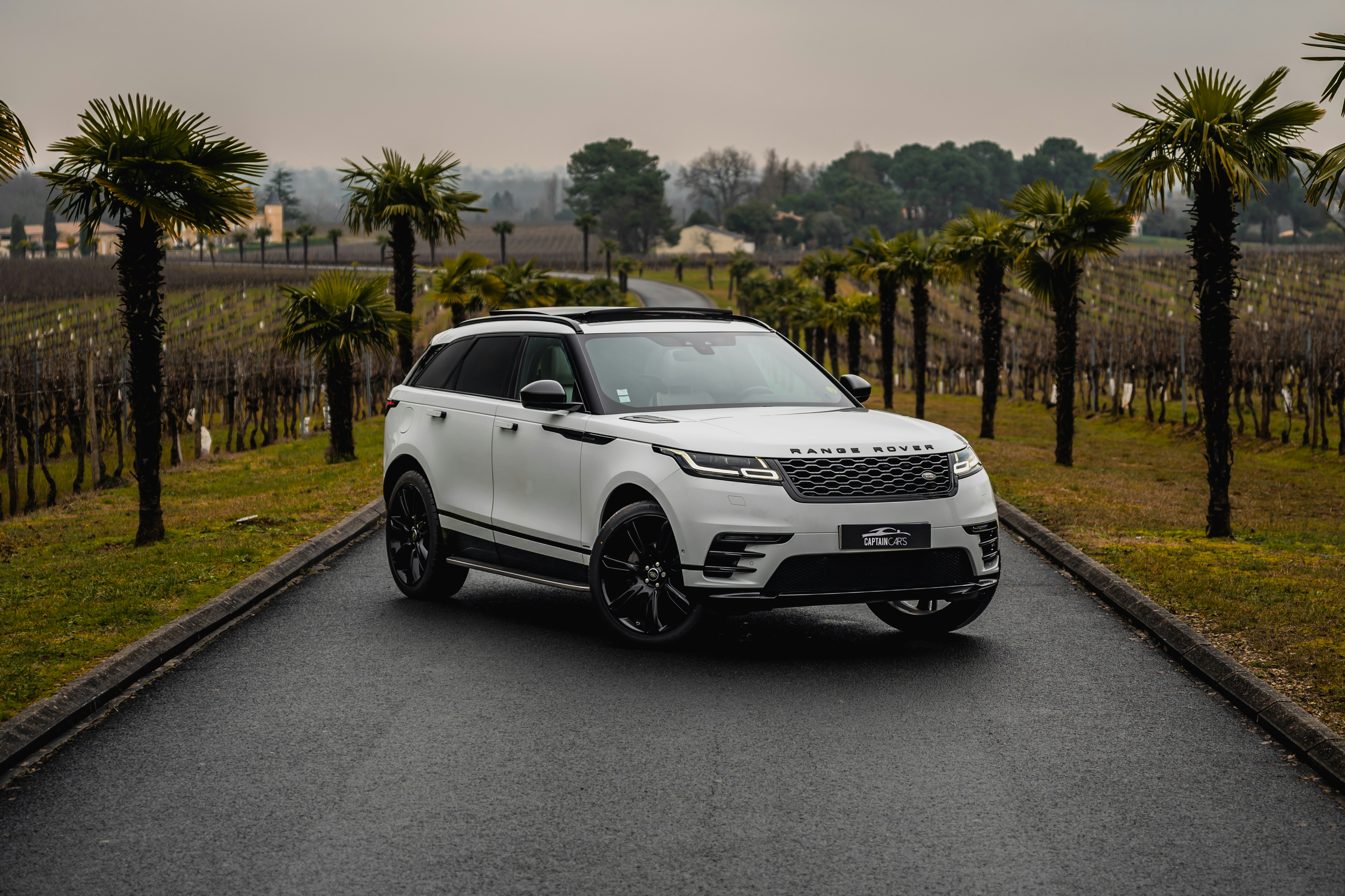 A white range rover parked on the side of a road photo – Free Captain ...