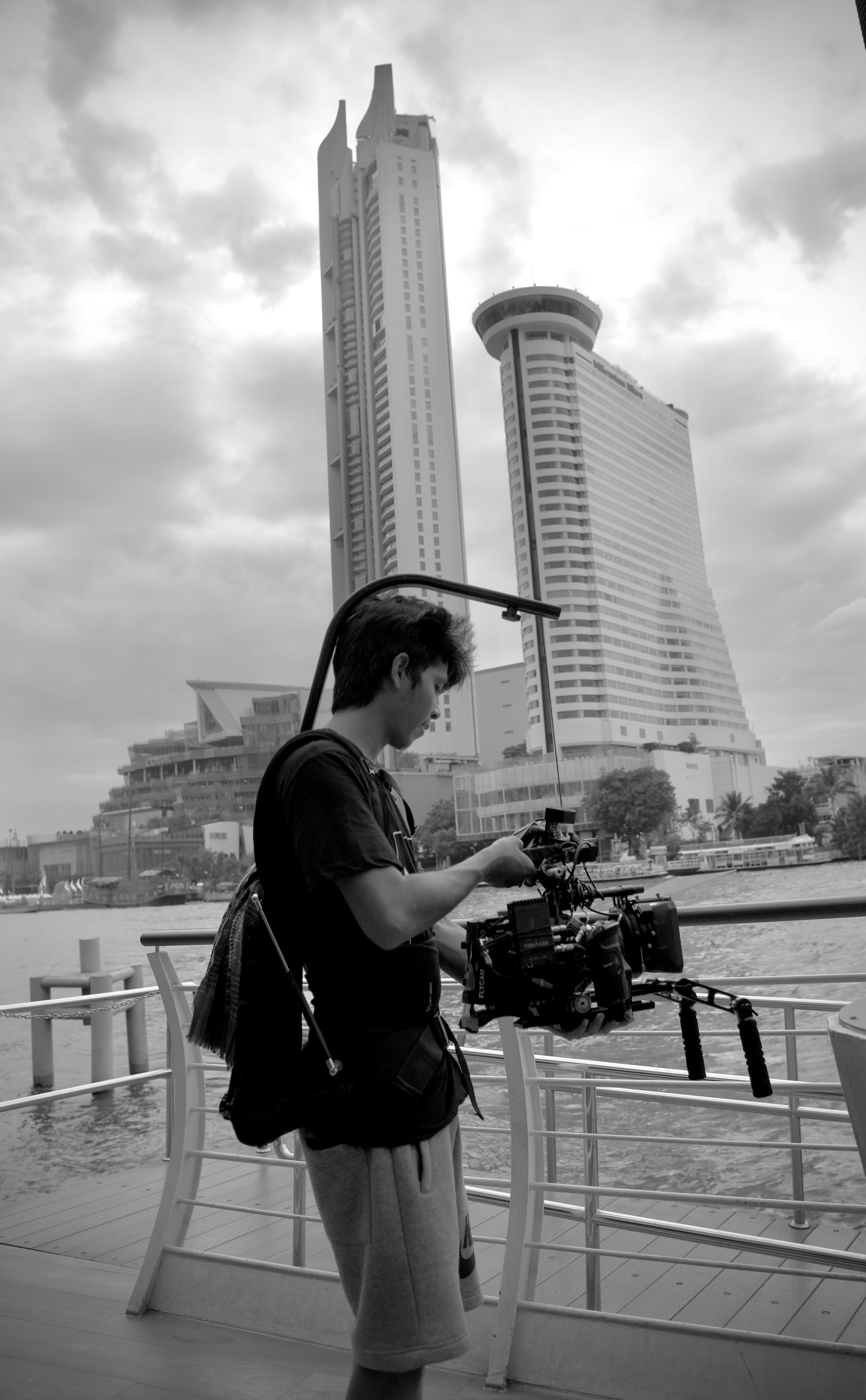 Cinematic Focus by the Marina: A Filmmaker and His Rig Against City Towers