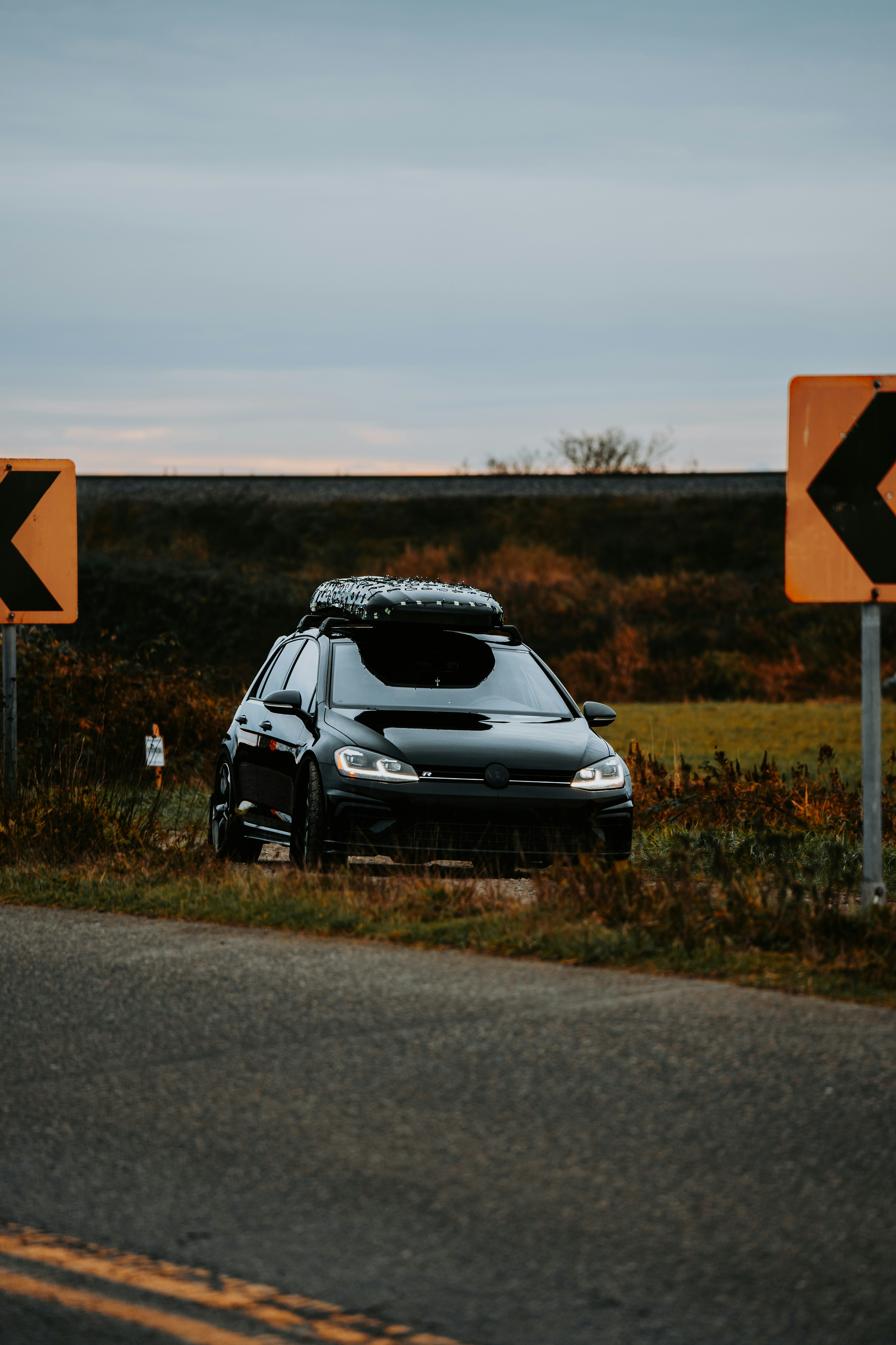 Midday Turn: A Dark SUV Pauses at a Winding Road