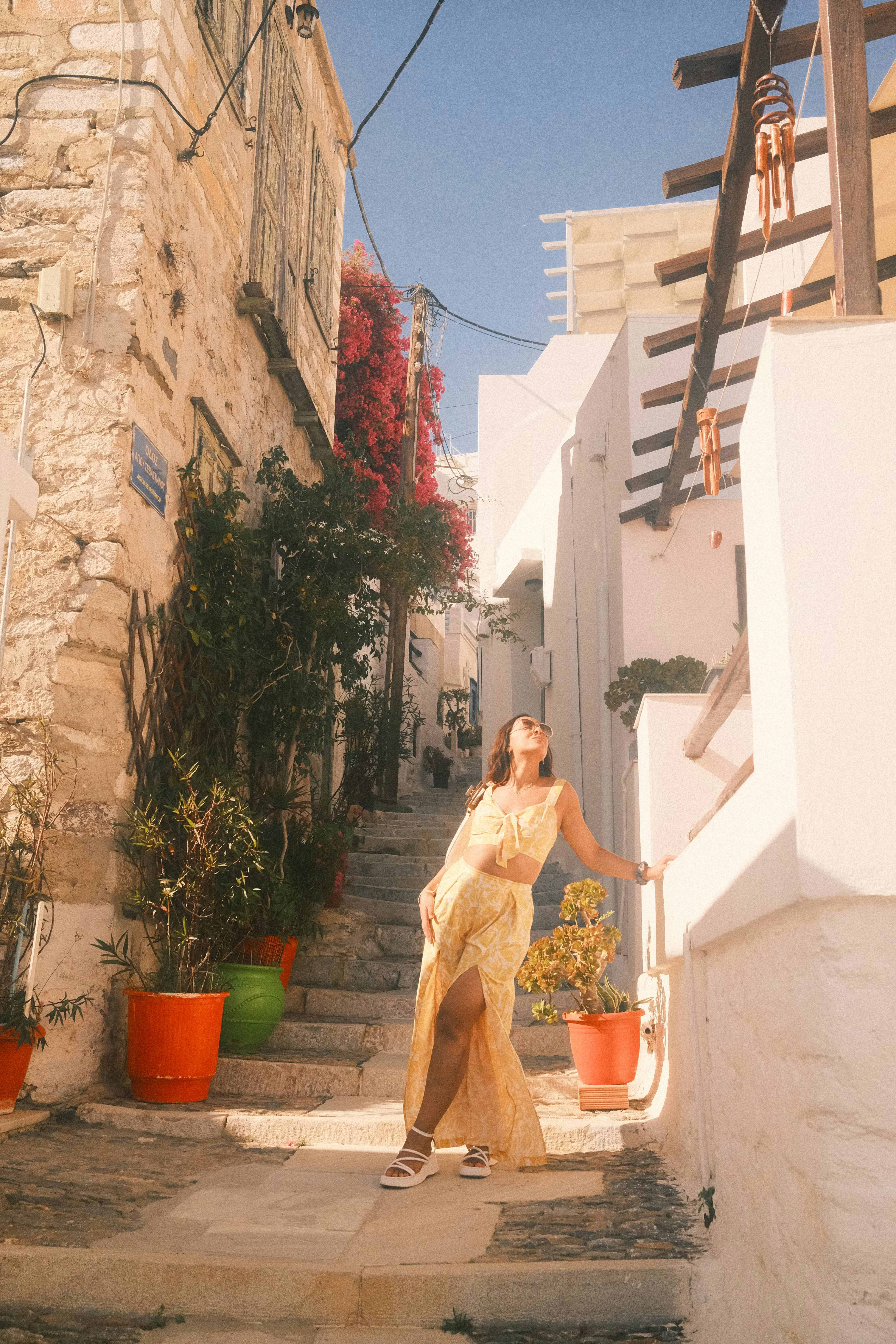 Sunlit Stairs, Yellow Dress: A Moment in a Whitewashed Cycladic Lane