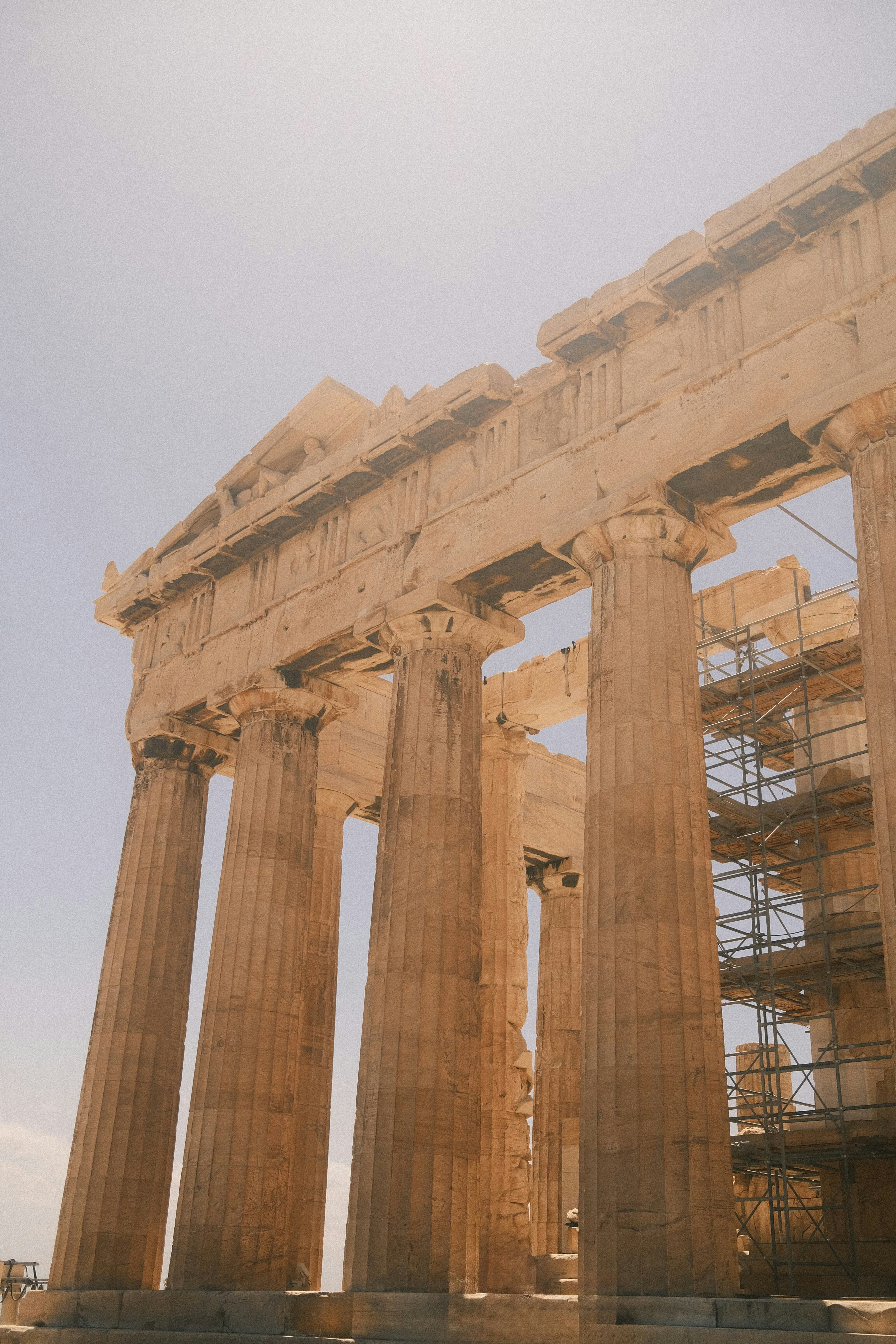 A large stone structure with columns and scaffoldings photo – Free ...