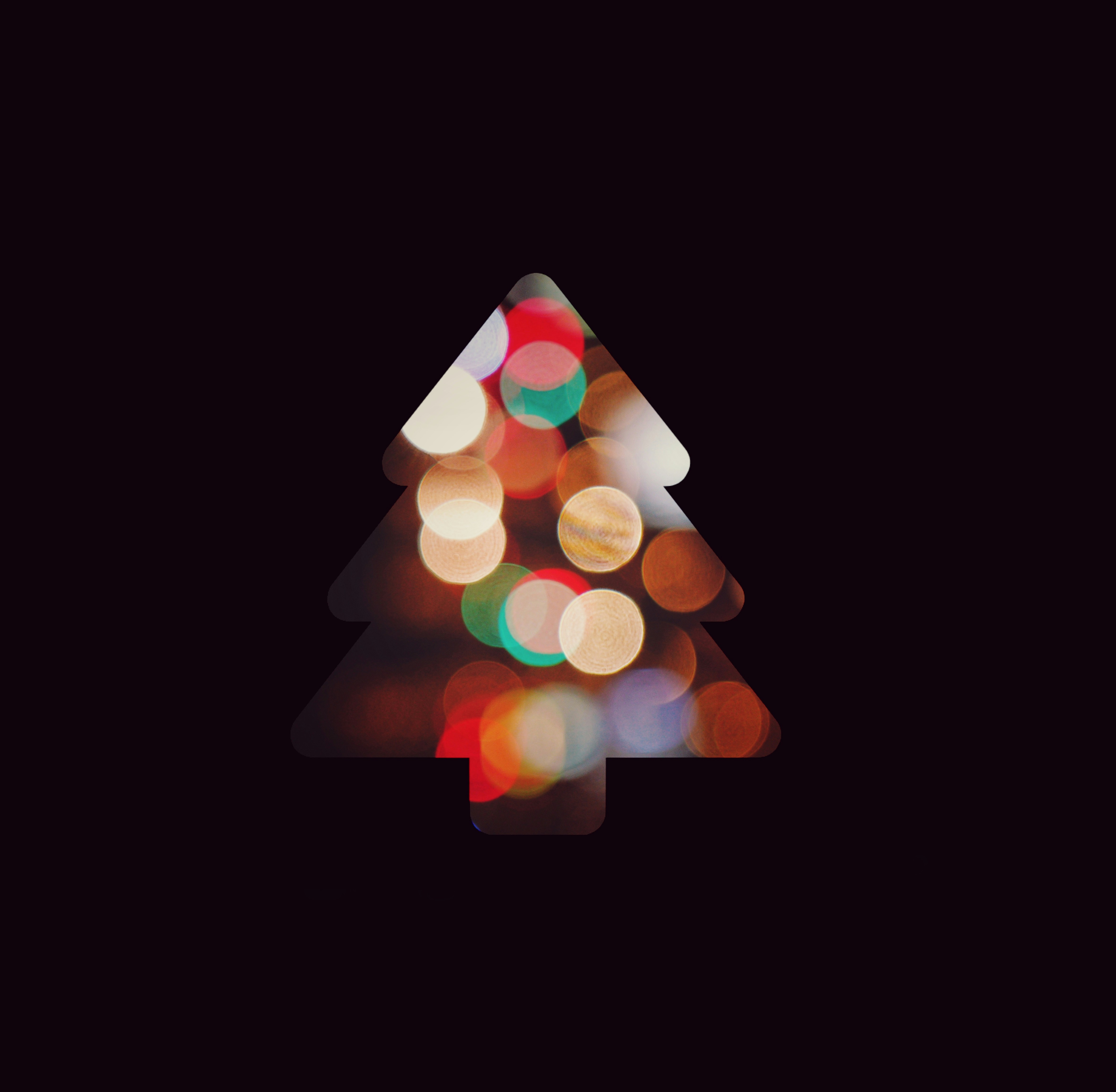 Velvet Night Christmas Tree: Neon Bokeh Within a Silhouette
