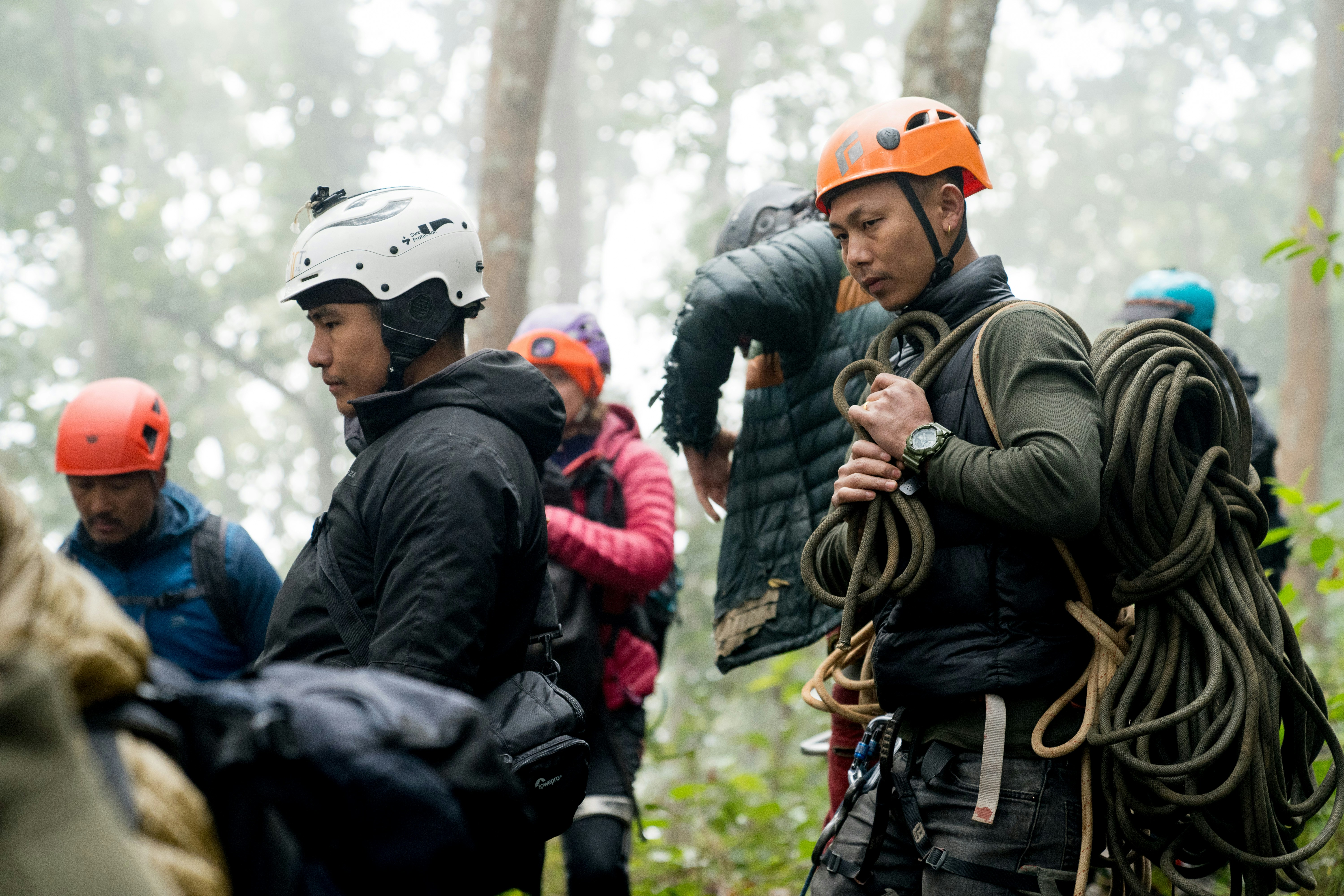 A group of people wearing helmets and climbing gear photo – Free Man ...