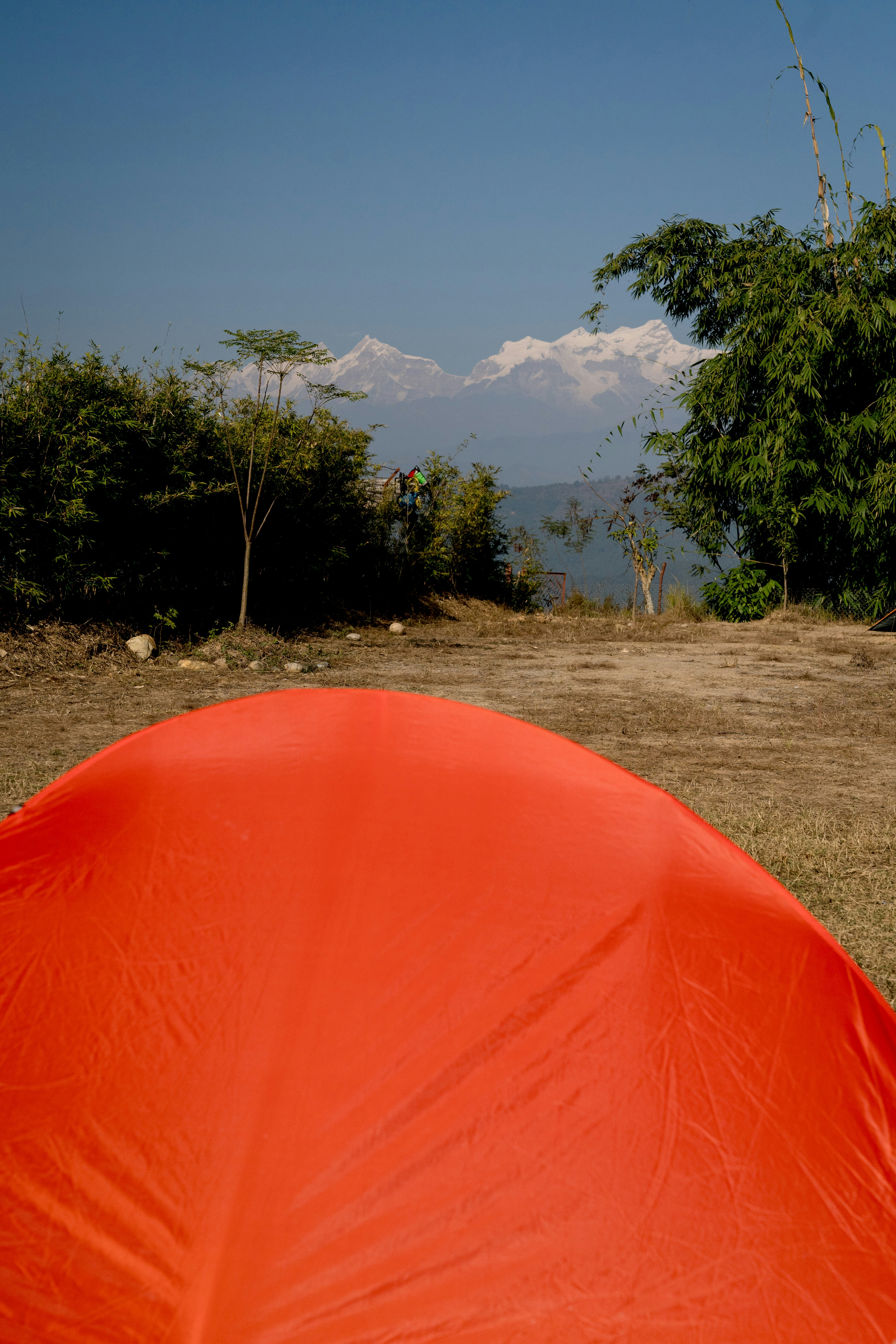 Crimson Tent at the Foot of Snow-Capped Peaks
