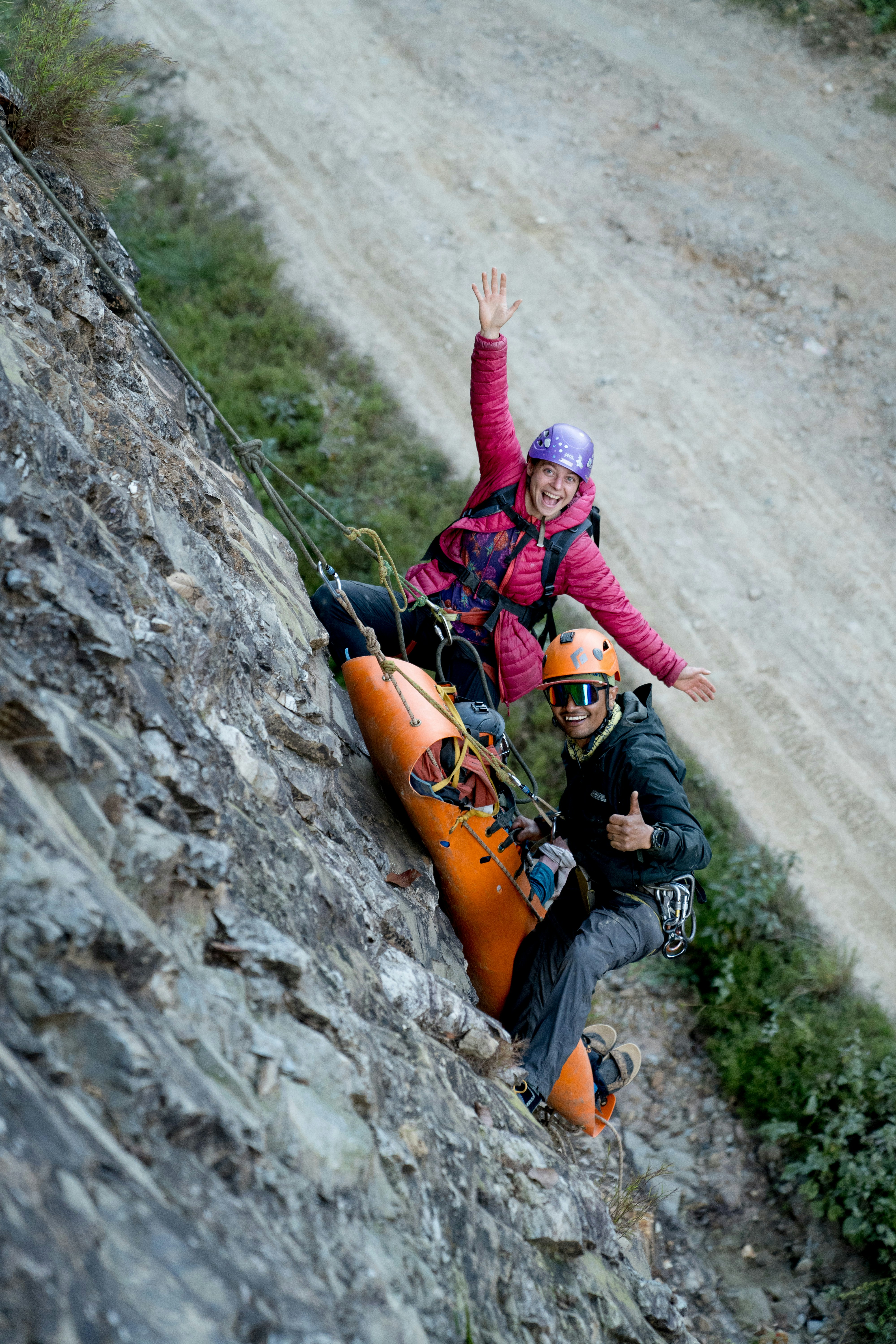 Ridge Reach: Climber Wave High on a Granite Face
