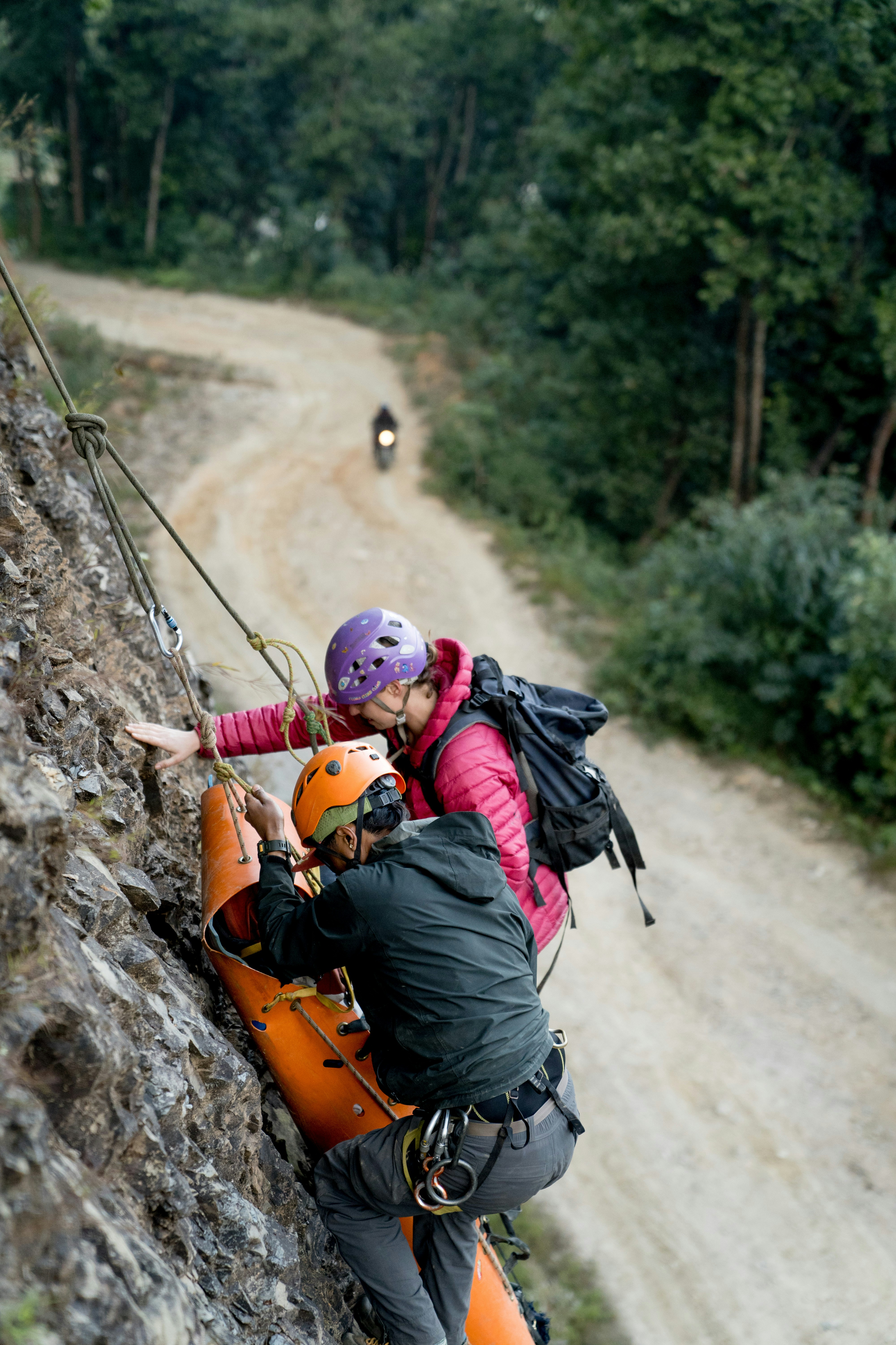 A person climbing up a steep hill on a rope photo – Free Man Image on ...