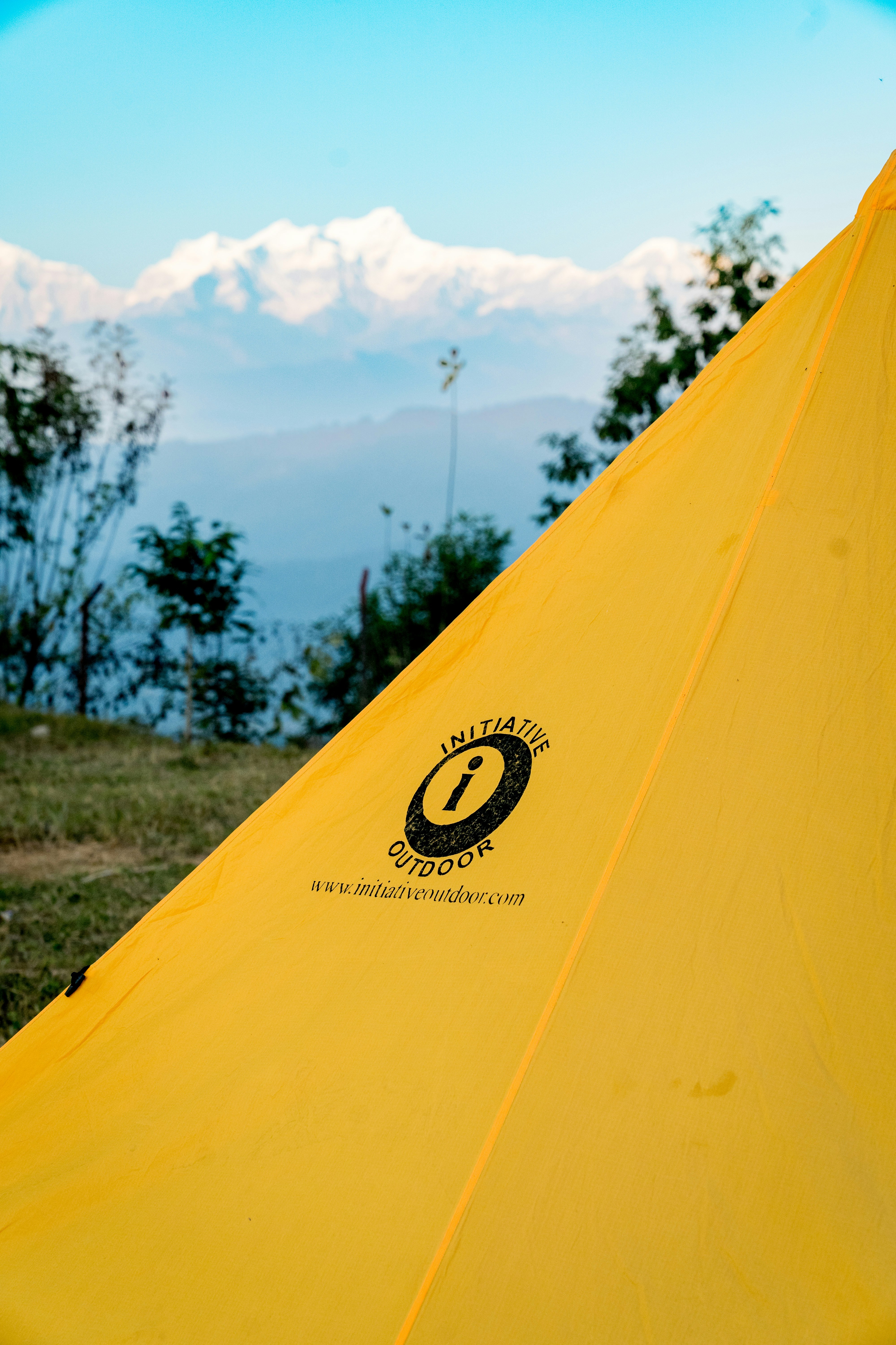 Bright Yellow Tent Against a Mountain Backdrop