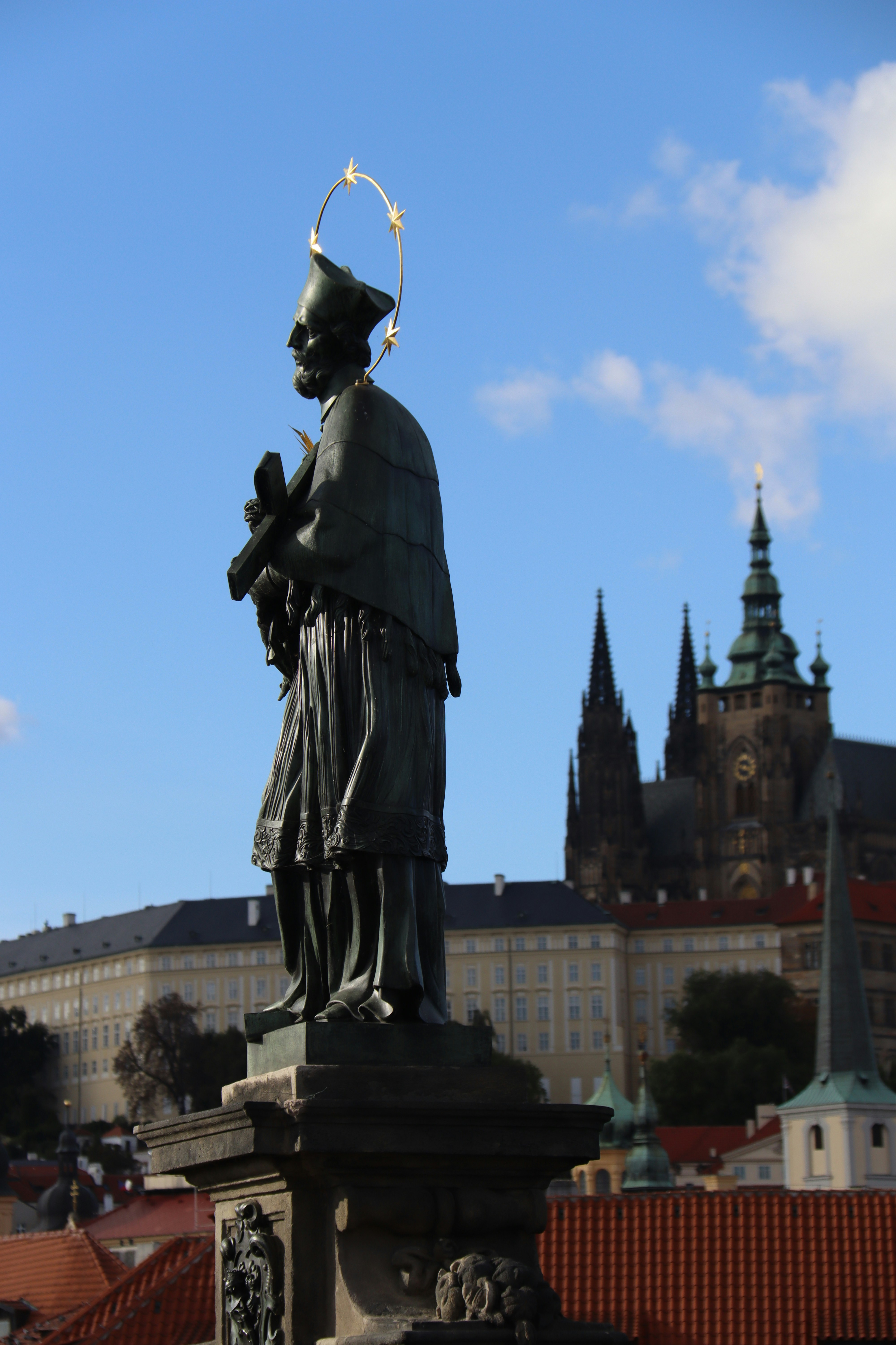 Haloed Figure: A Monumental Saint Beside a Prague Skyline