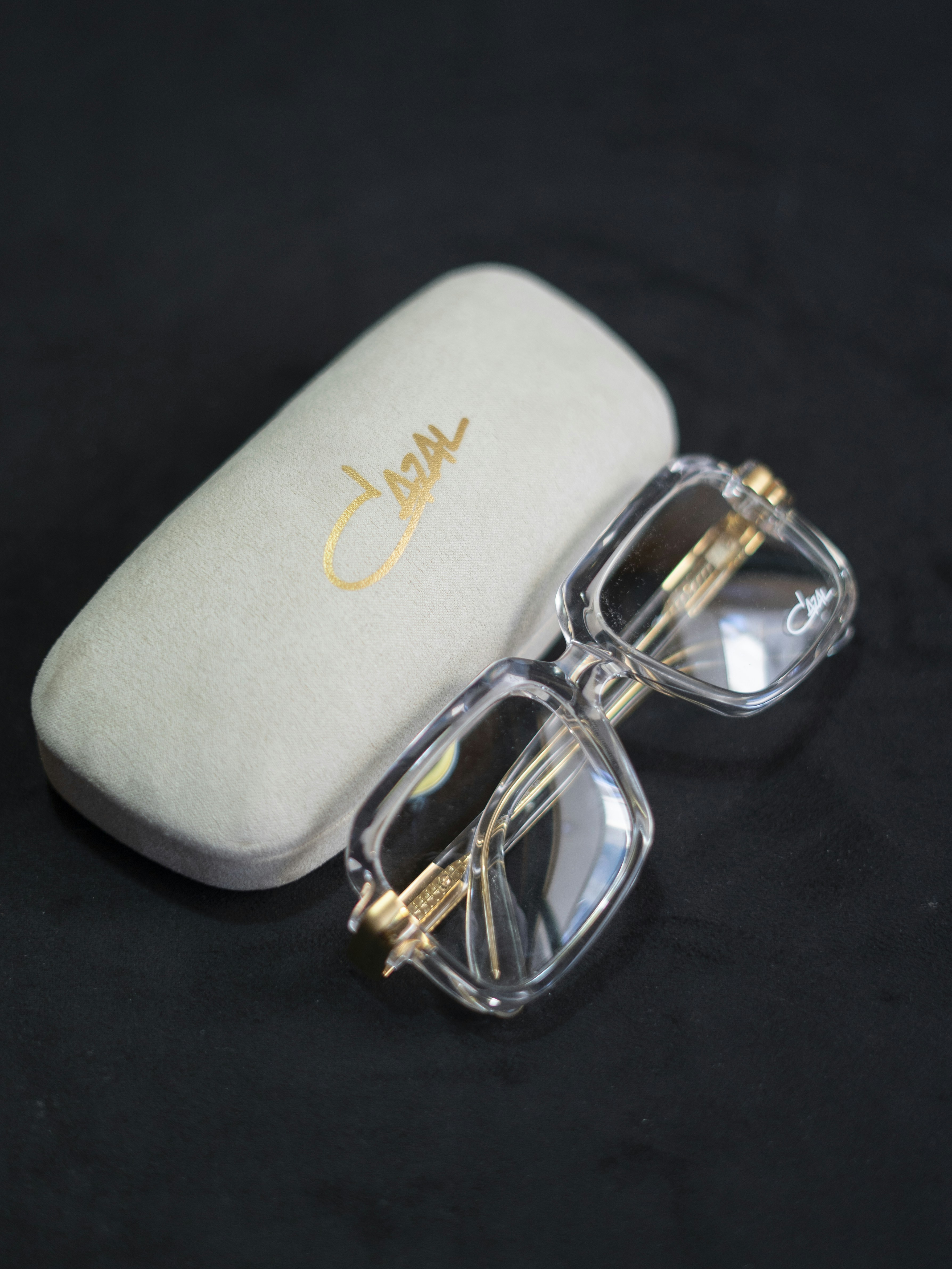 Gold-Accented Eyewear Resting Beside a Velvet Case