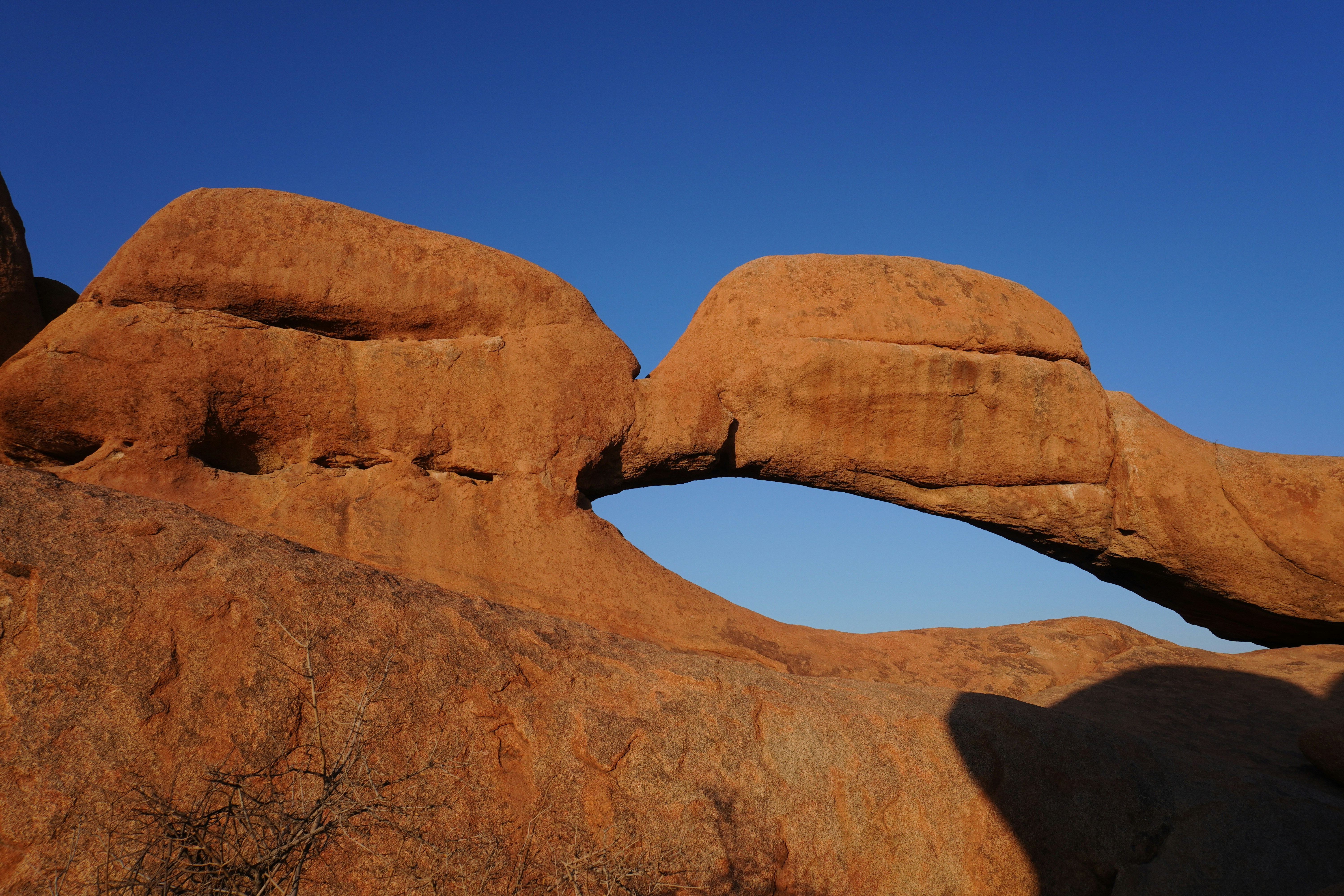 Cerulean Sky Through a Rust-Red Desert Arch
