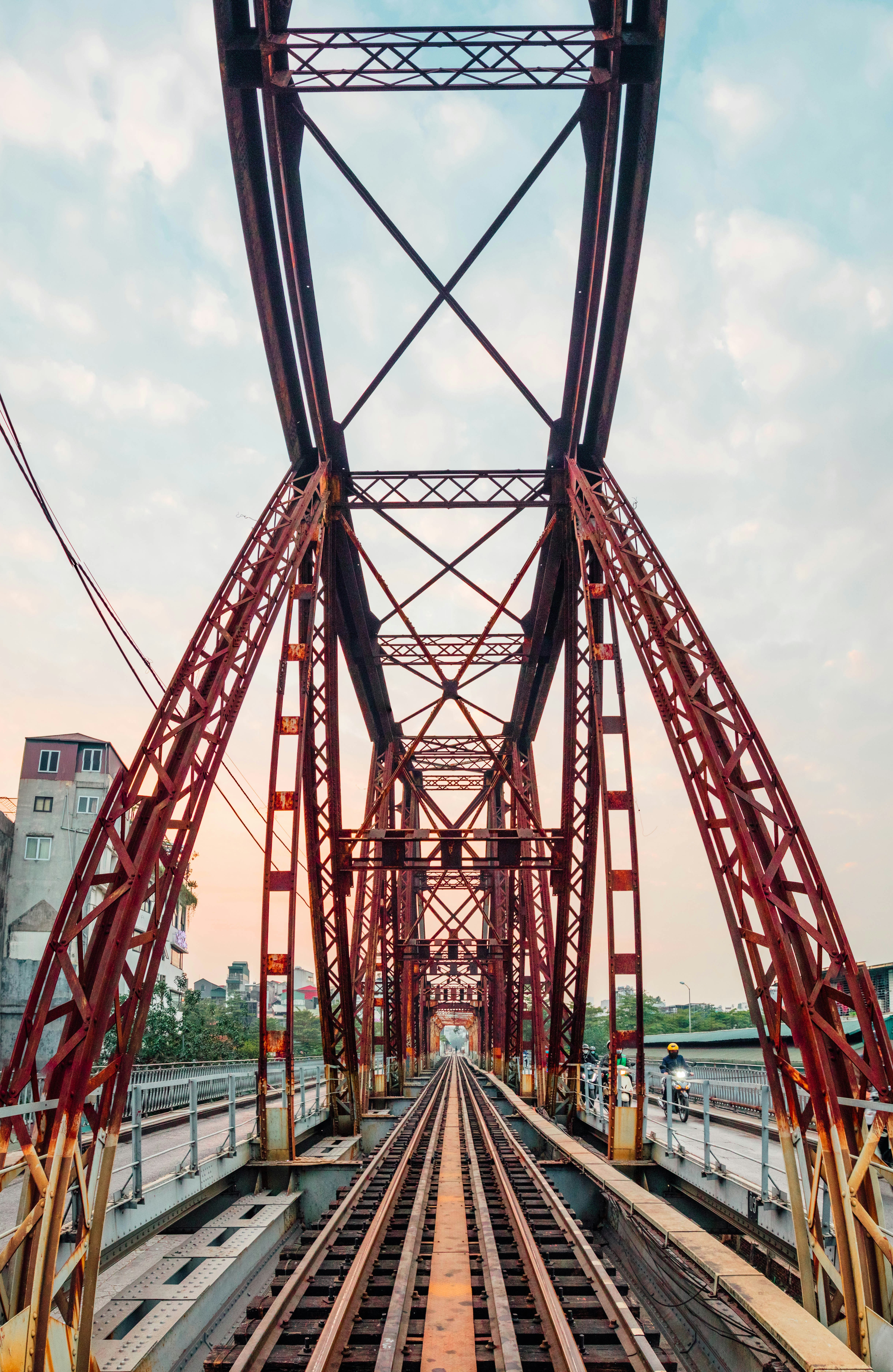 A train track going across a bridge over water
