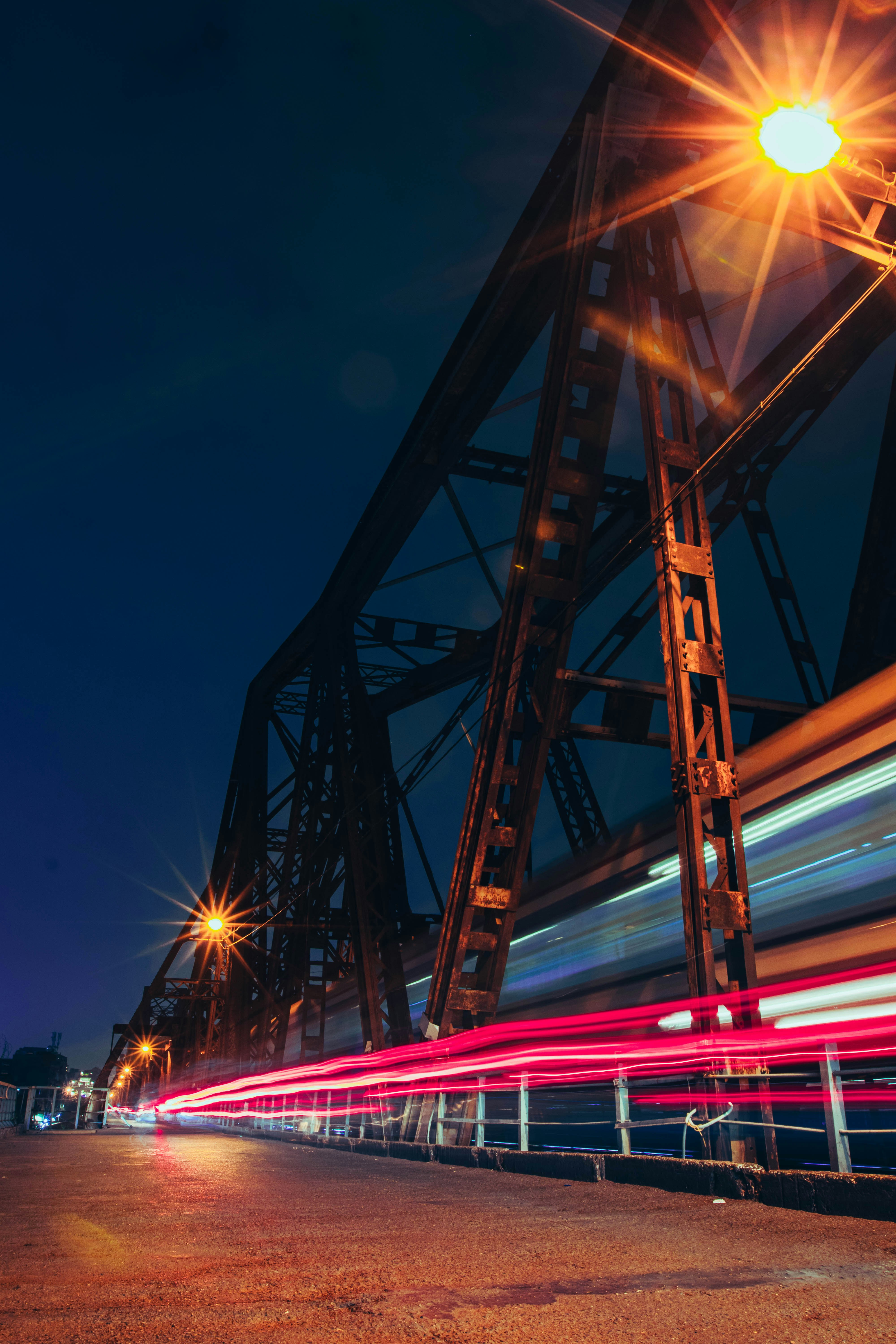 A train traveling over a bridge at night photo – Free Hanoi Image on ...