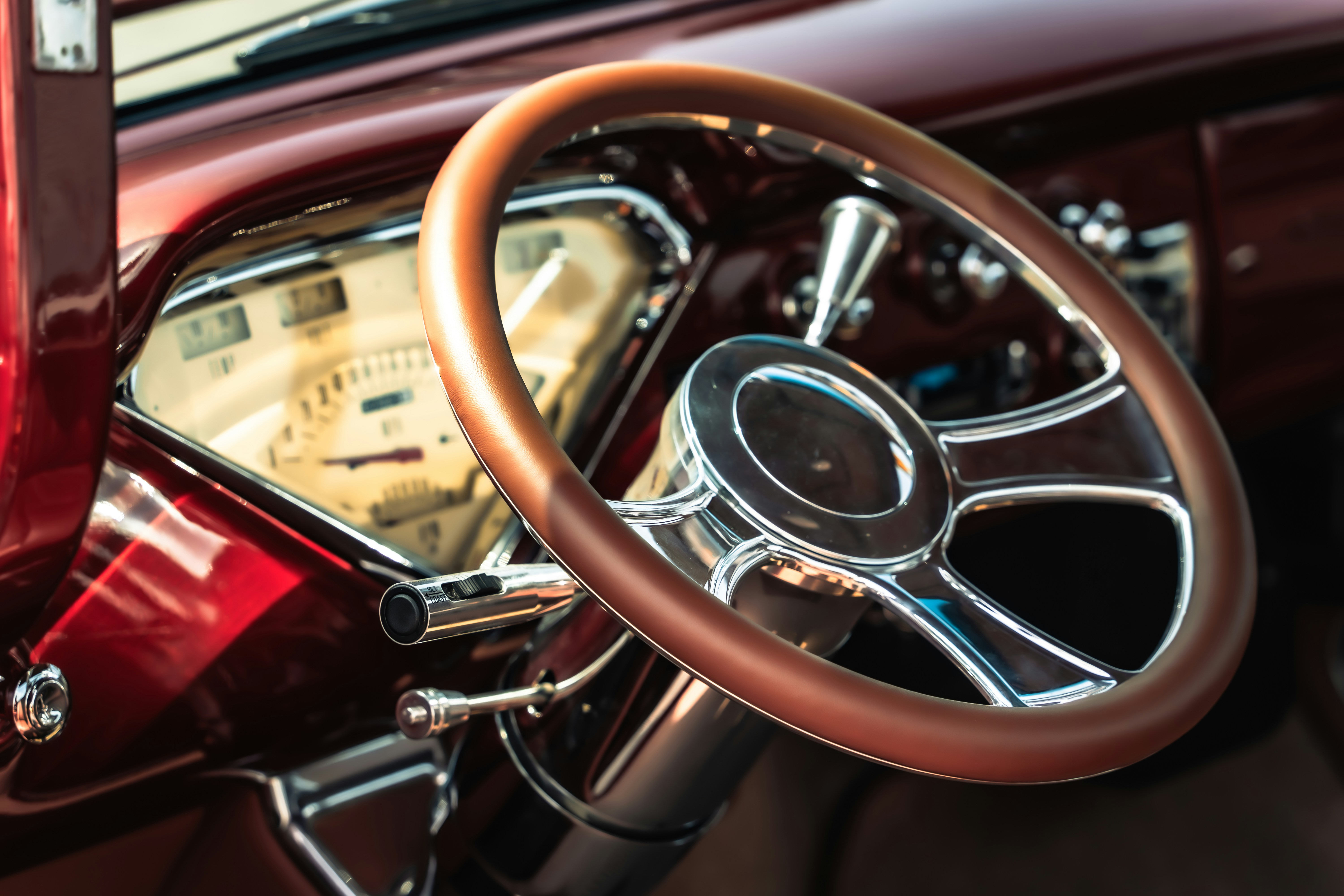 Nostalgic cockpit: vintage steering wheel and dials under warm cabin light