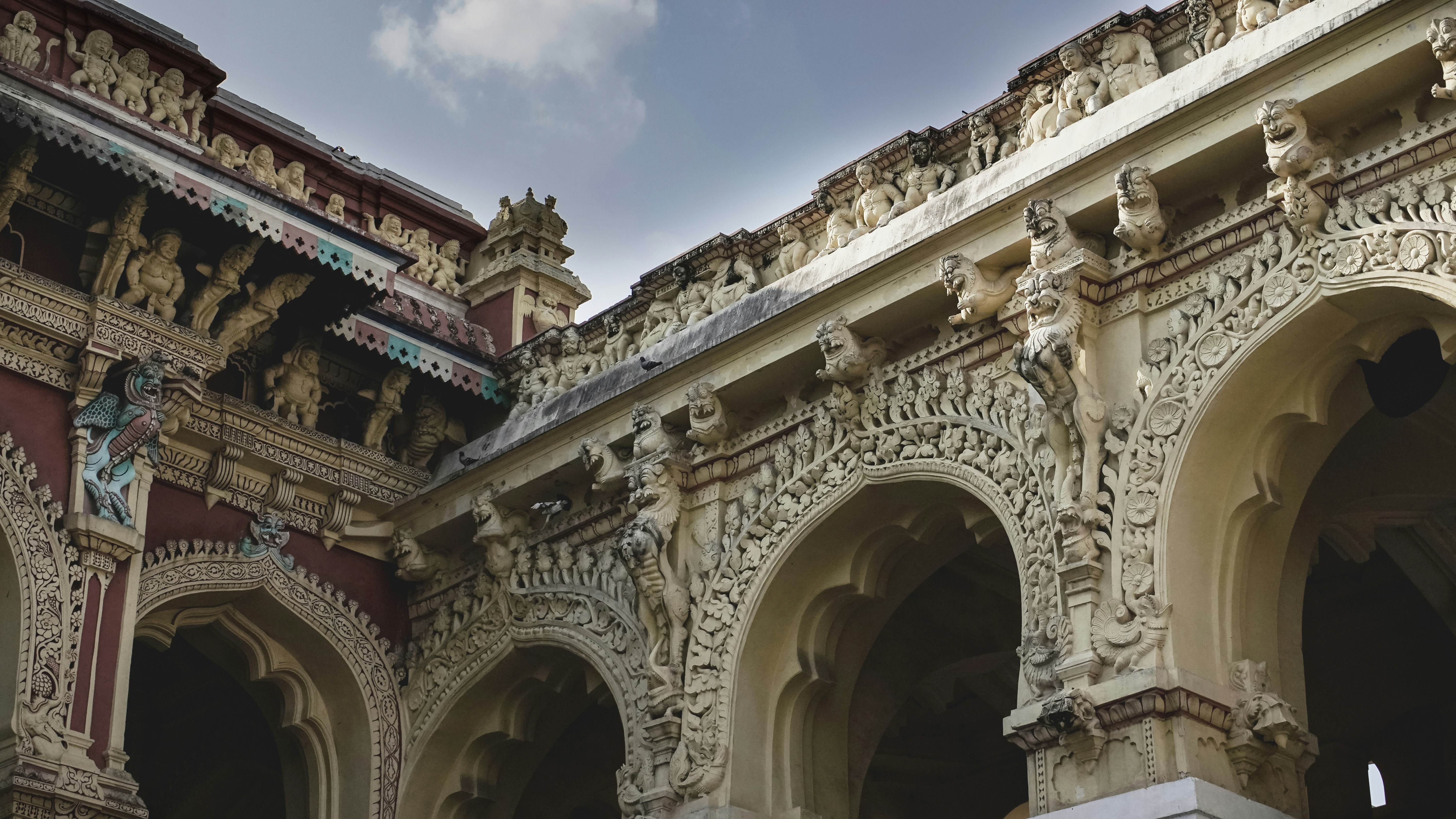 Stone Choir: Sunlit Archways and Carved Frieze of a Temple Facade