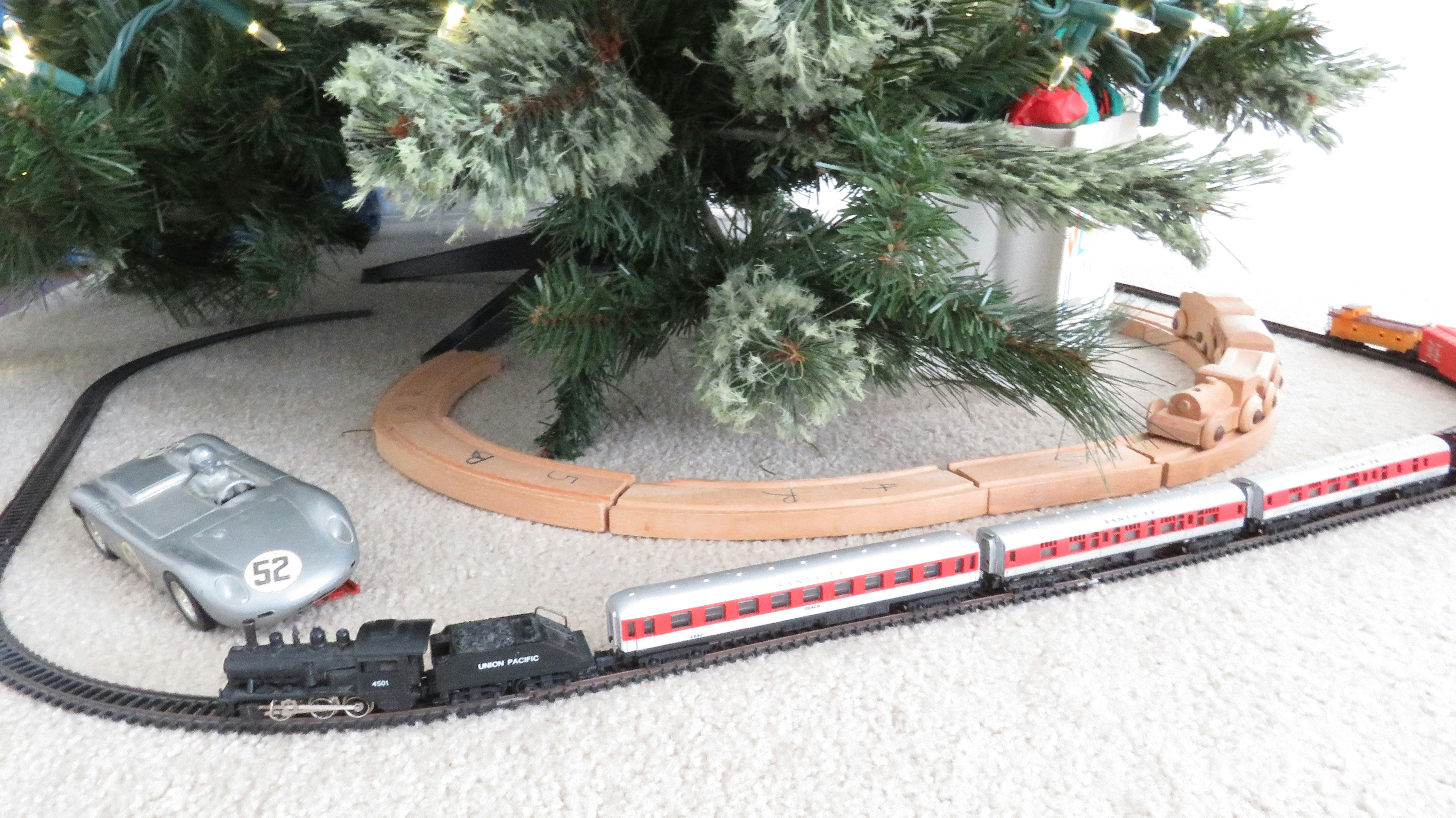 Toy Train Emerges from the Christmas Tree Beneath
