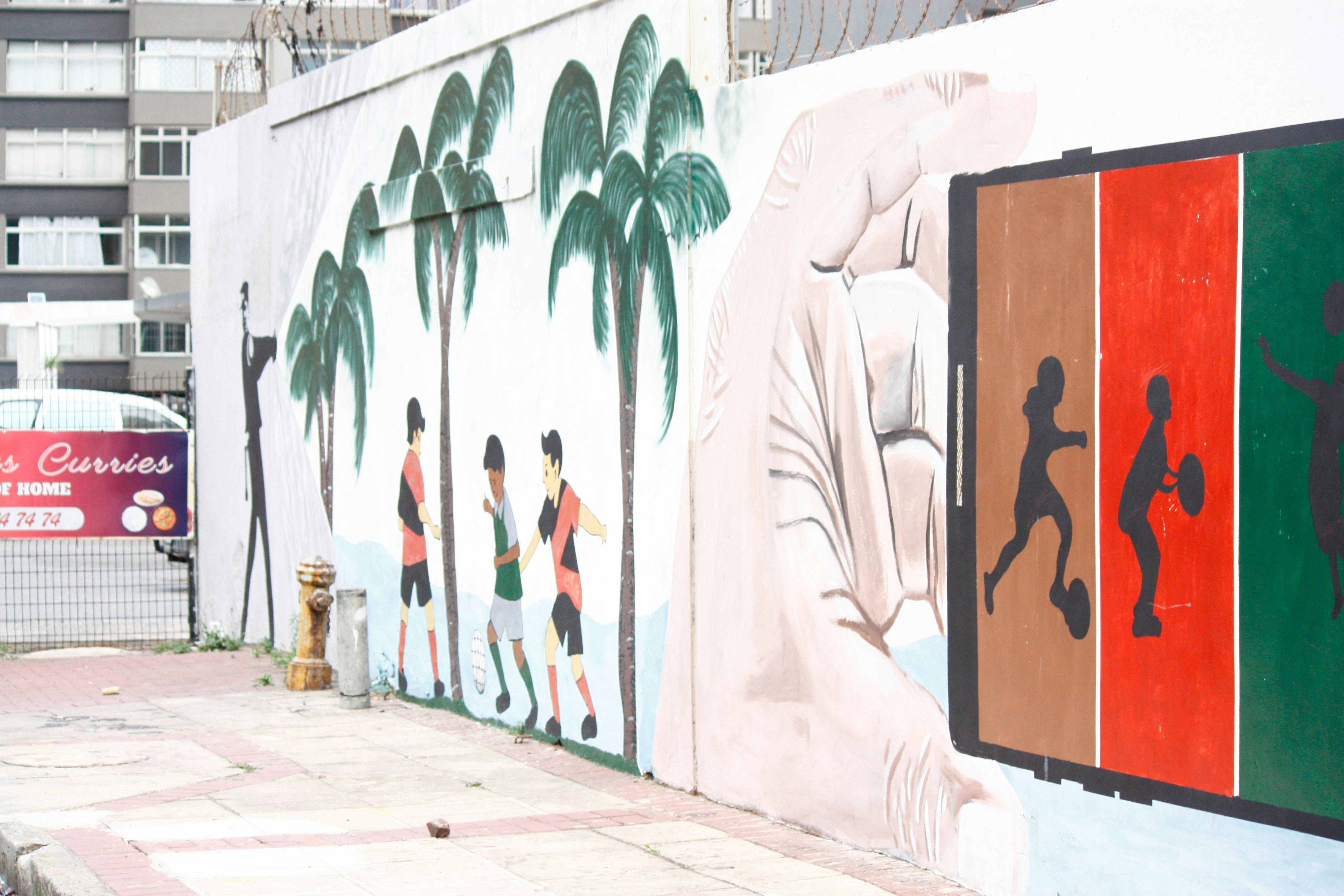 A mural of a man running on the side of a building photo – Free Human ...