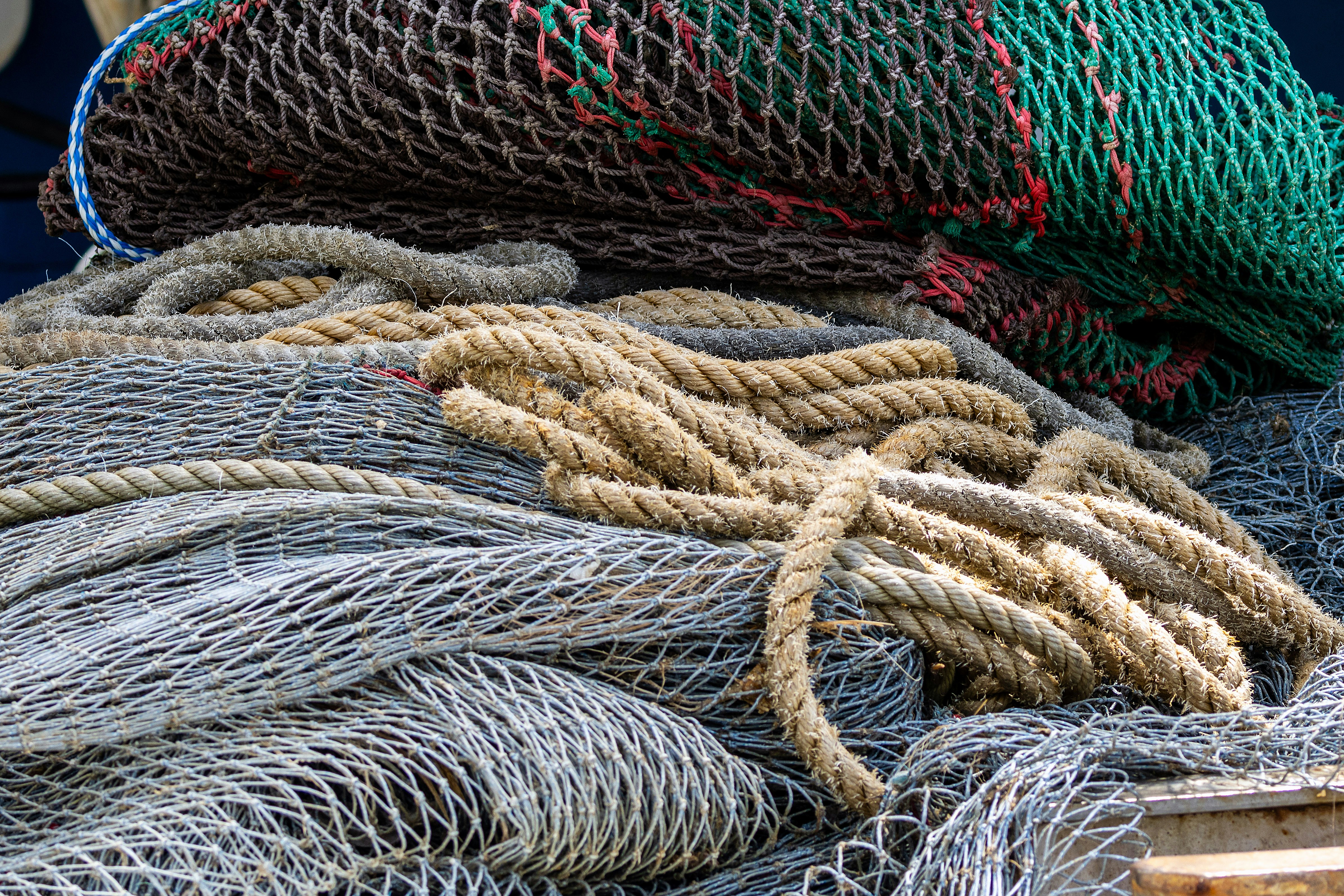 A pile of fishing nets piled on top of each other photo – Free Trawler ...