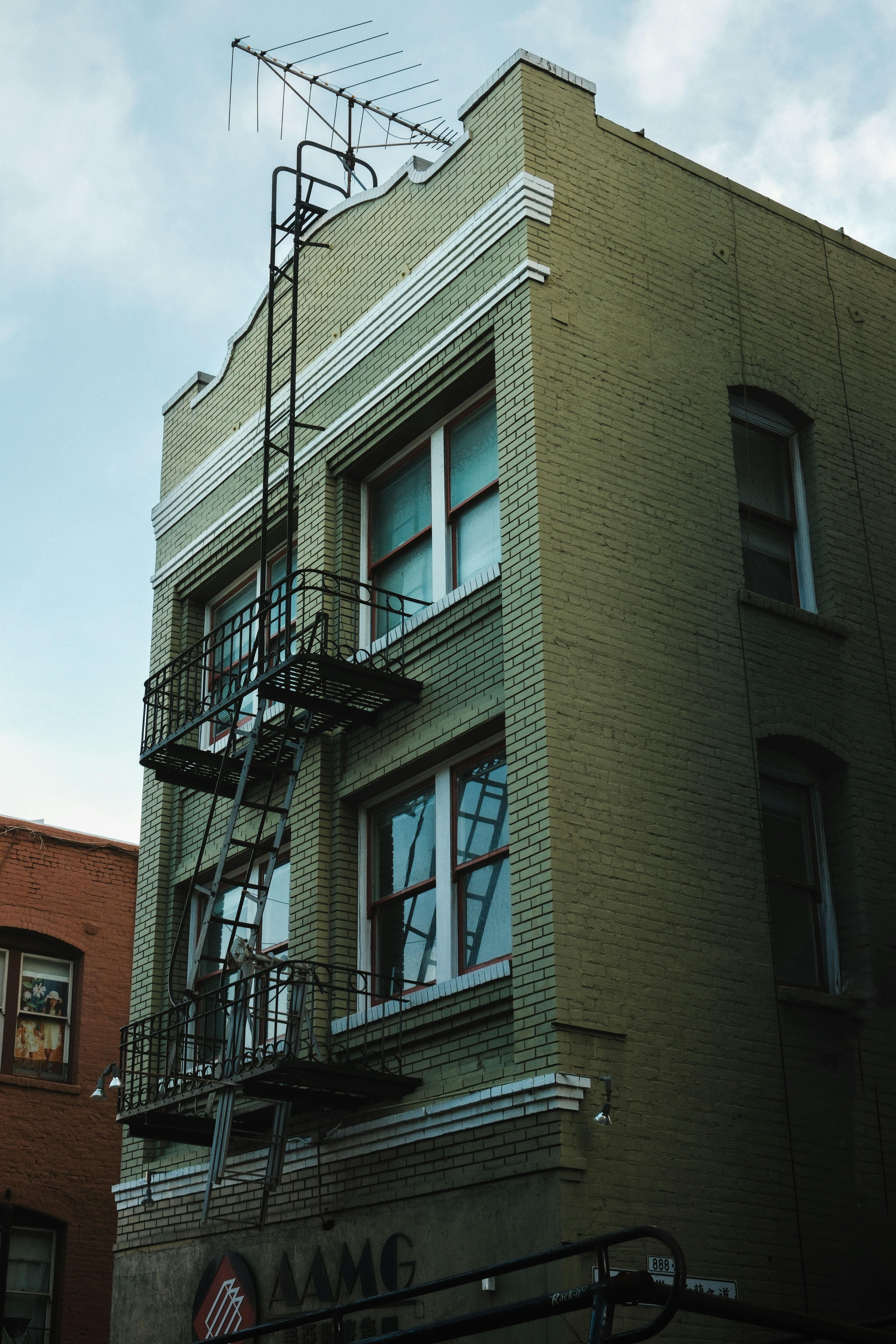 A tall building with a fire escape on top of it photo – Free Building ...