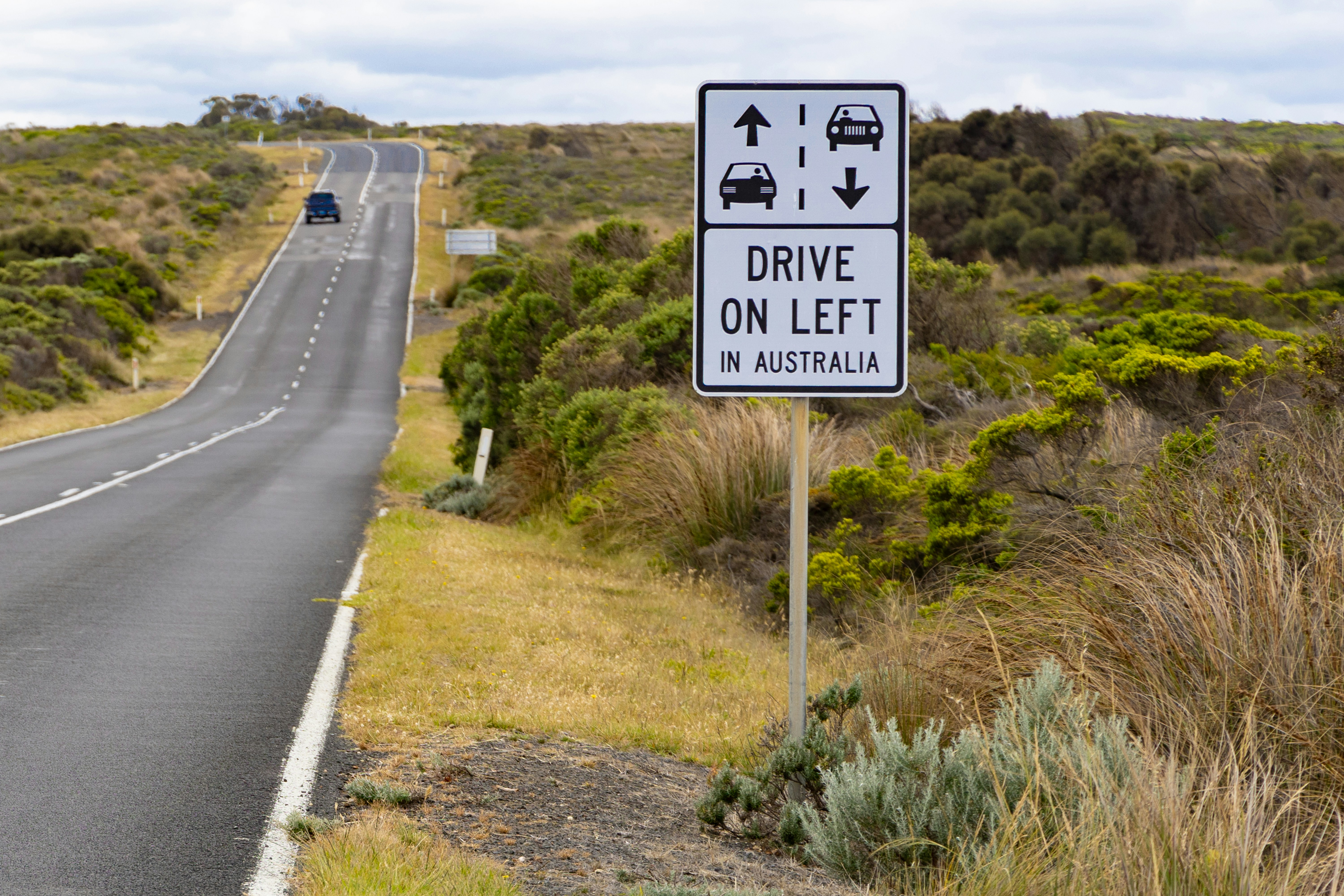 A sign on the side of a road that says drive on left photo – Free ...