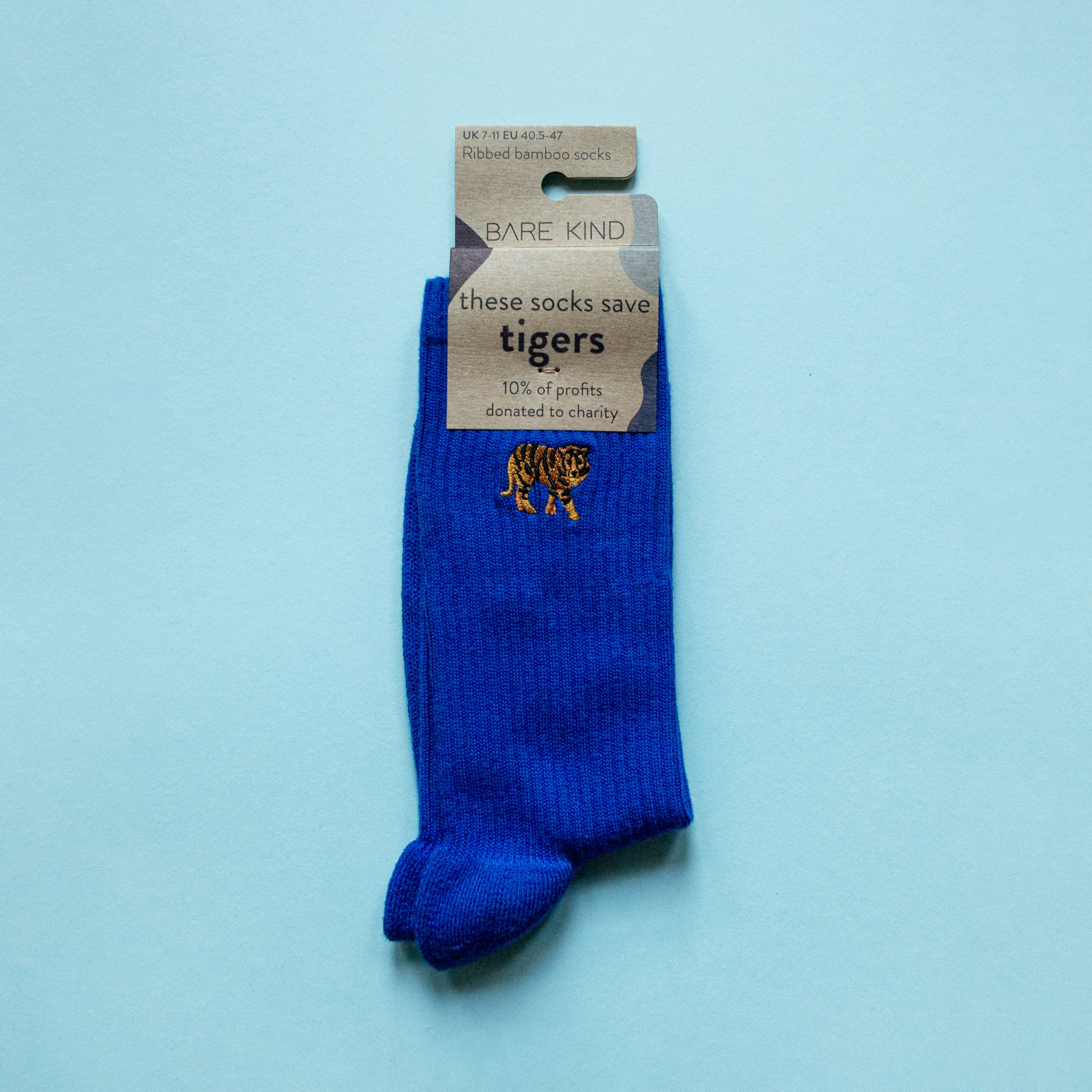 Tiger Branding on a Bold Blue Sock: A Clean Studio Charity Portrait