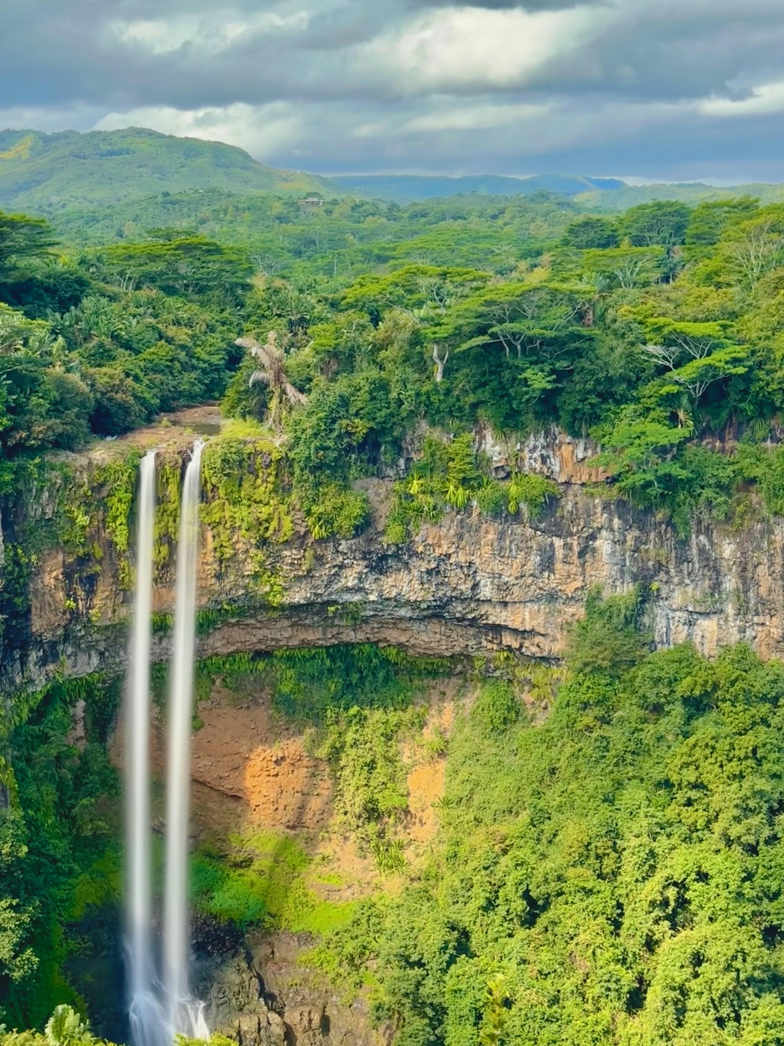 Twin Slender Falls Carving a Verdant Cliffside Gorge