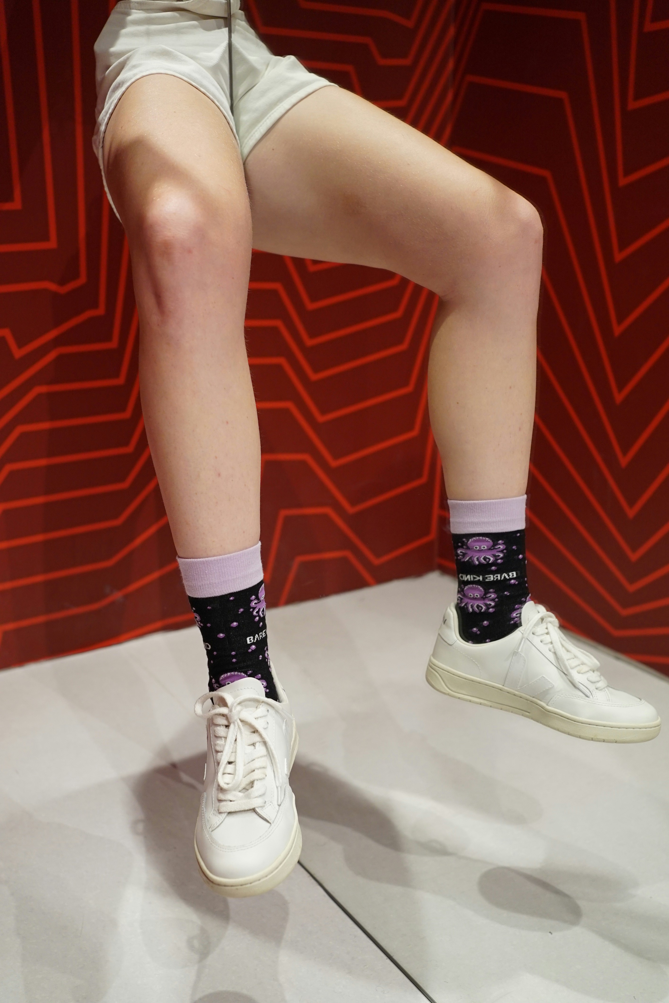 A woman in white shorts and socks standing on a stage photo – Free ...