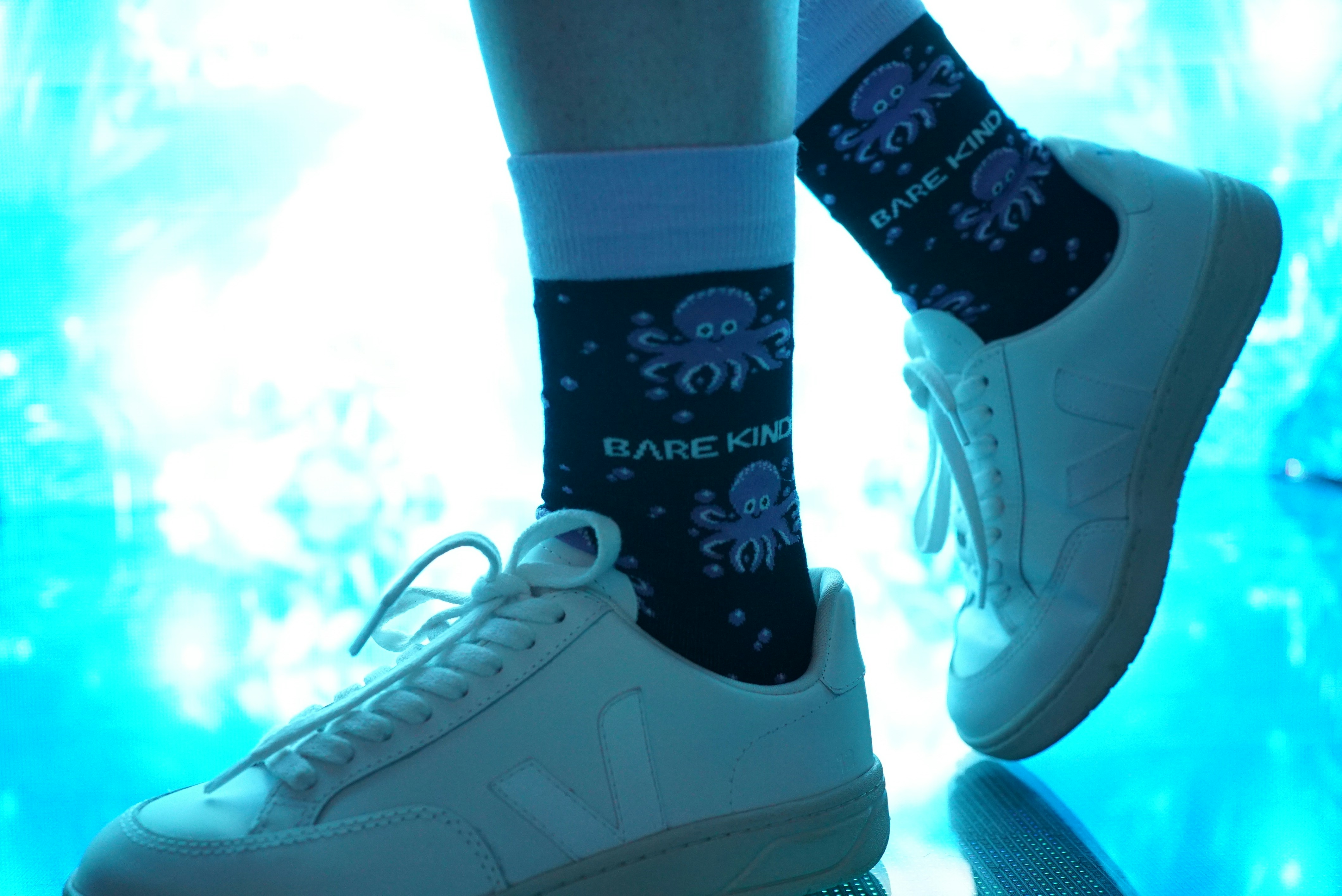 Cyan Stage for White Kicks: A Neon Backlit Close-Up