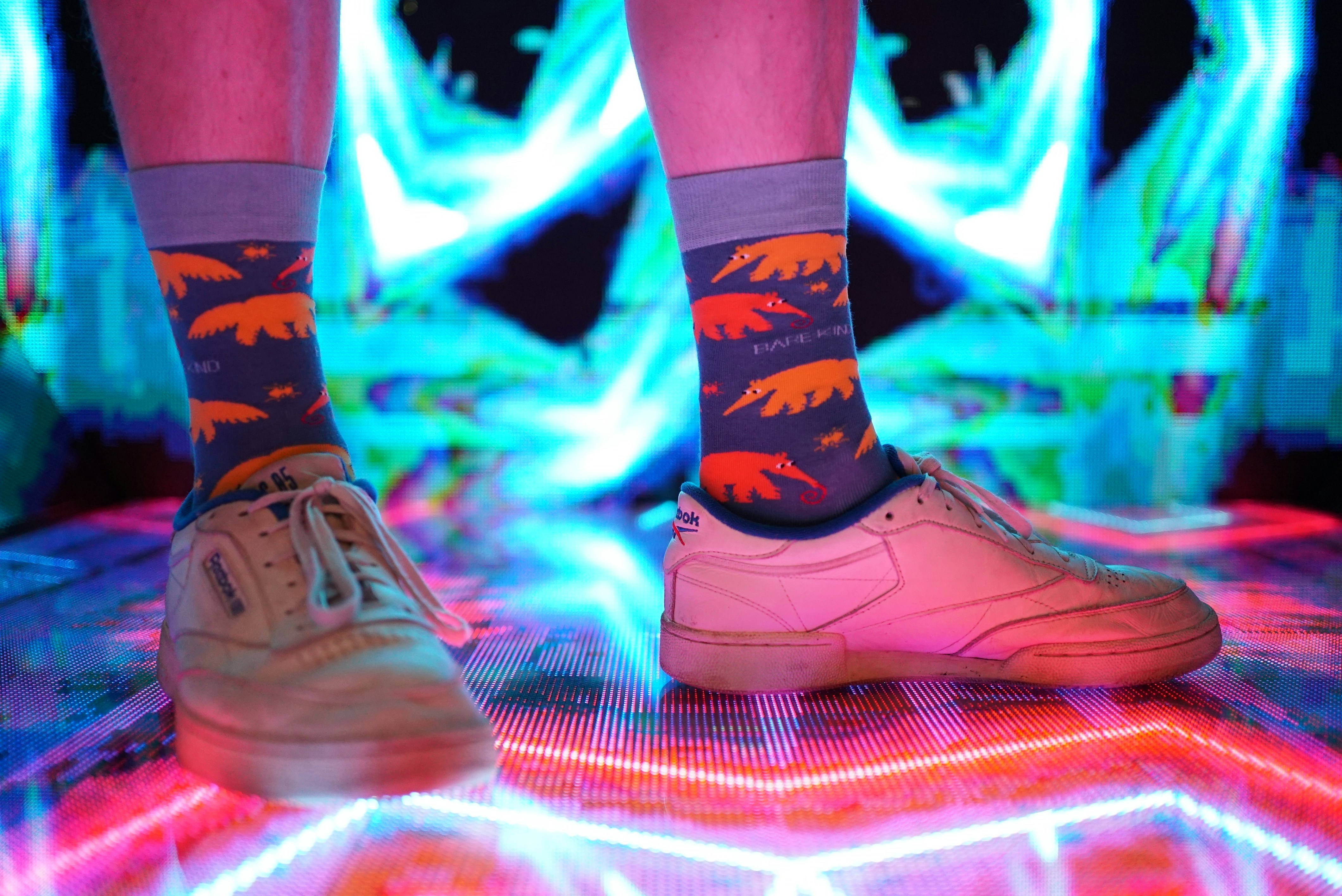 Neon Steps: Feet in a Pulsing Light Stage