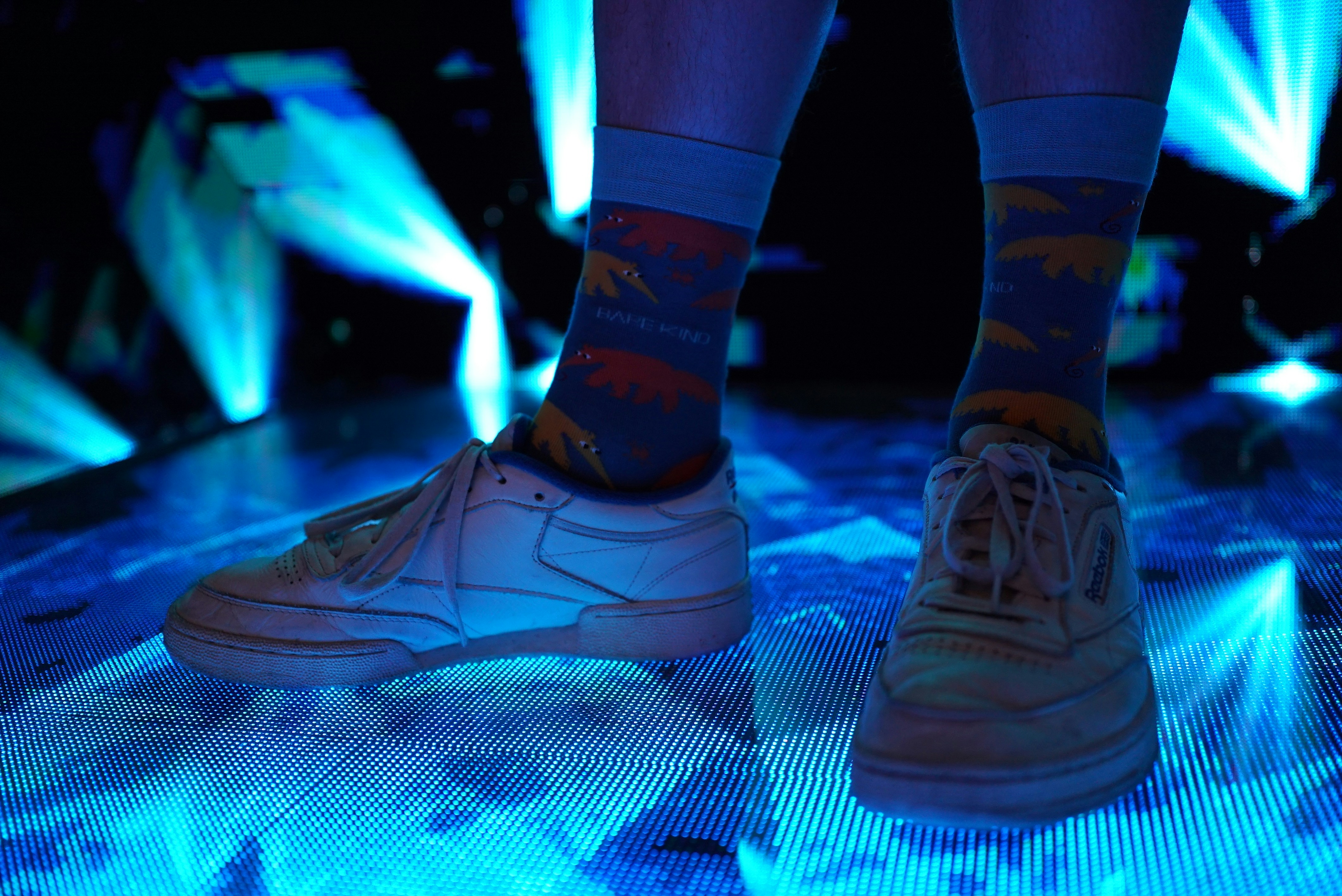 Footlights on Neon Stage: Sneakers Amid Electric Waves