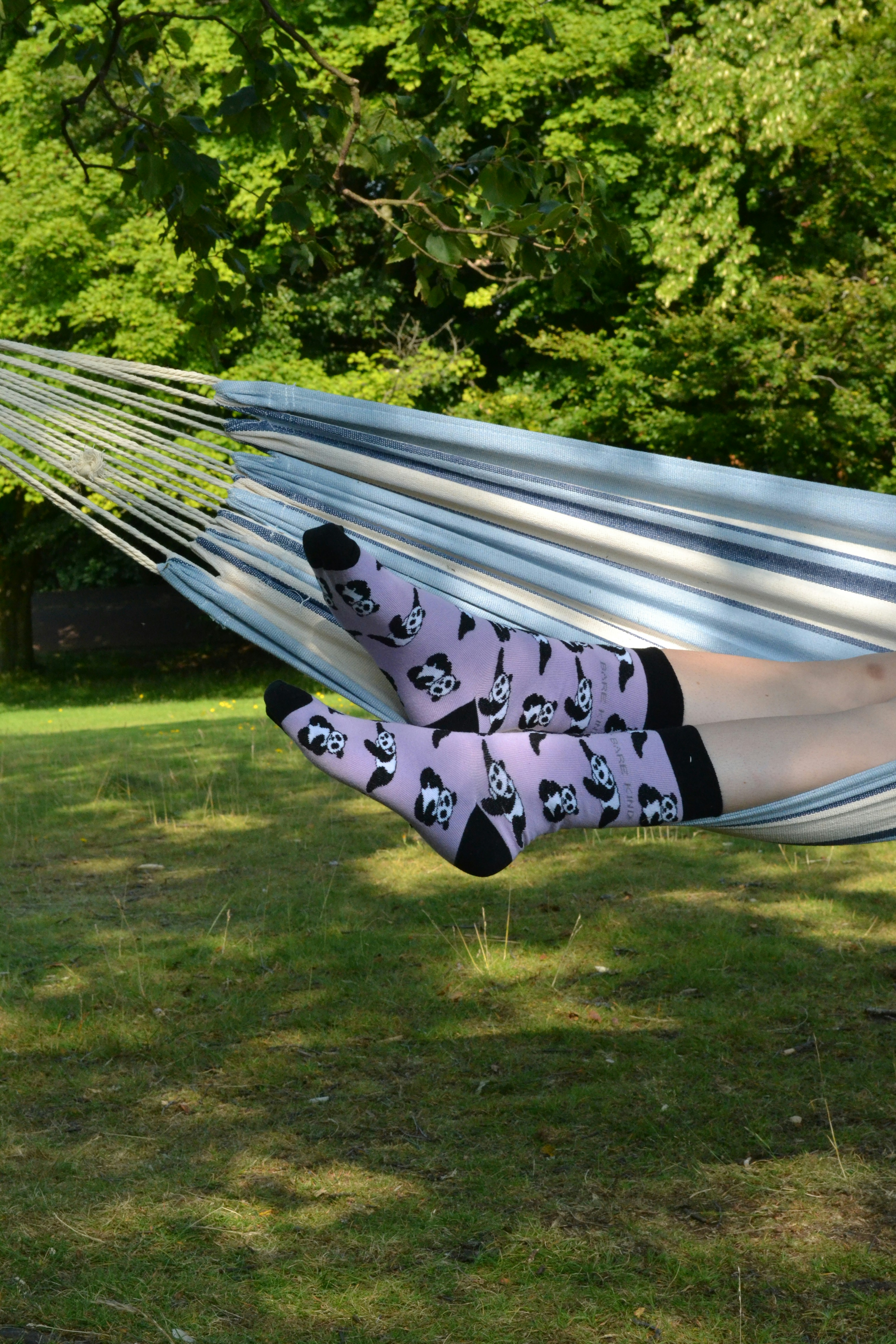 Panda-Print Feet Lounge in a Sunlit Park Hammock