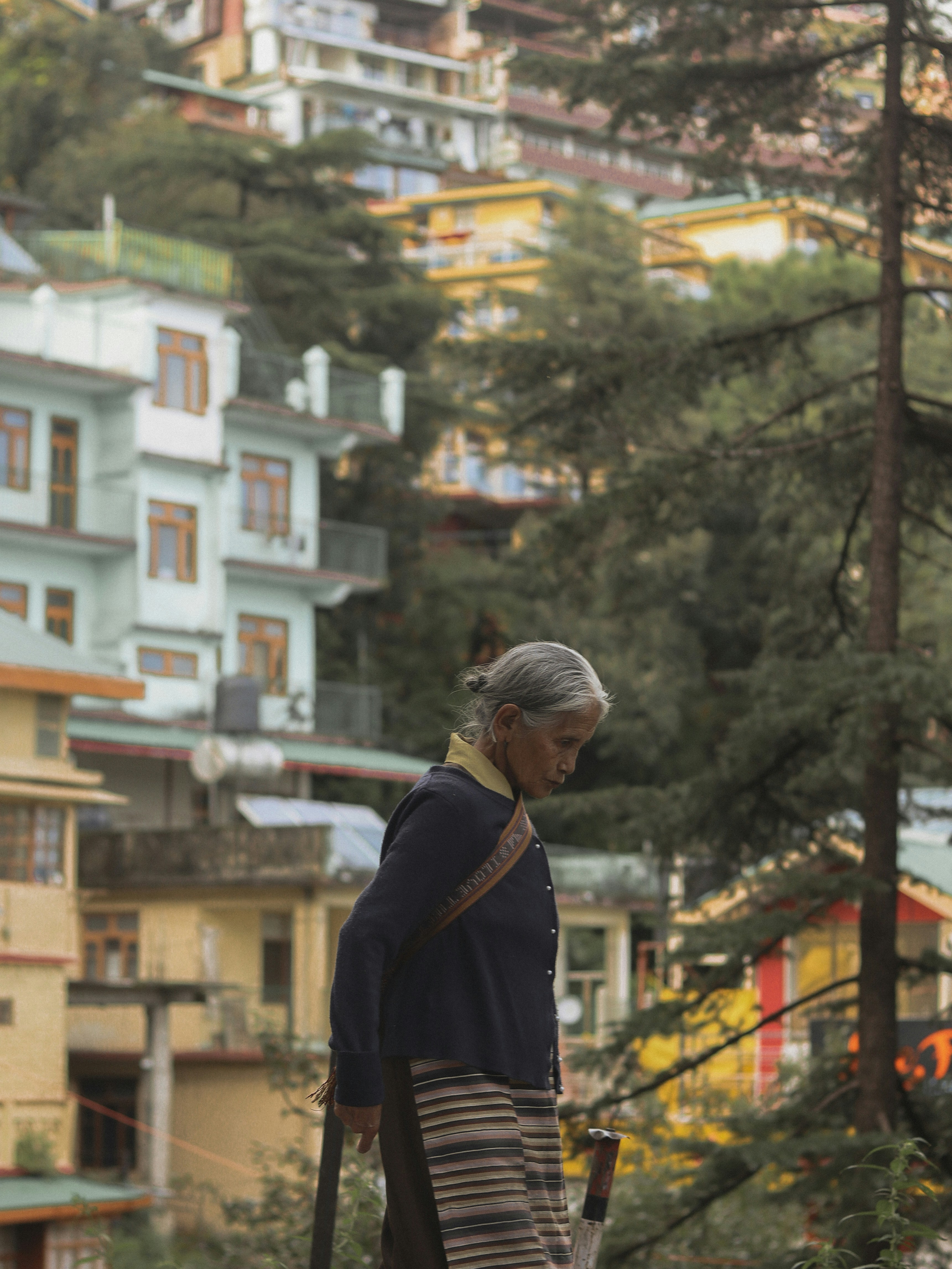Colorful Terraces and Quiet Steps: An Elderly Figure in a Hill Town