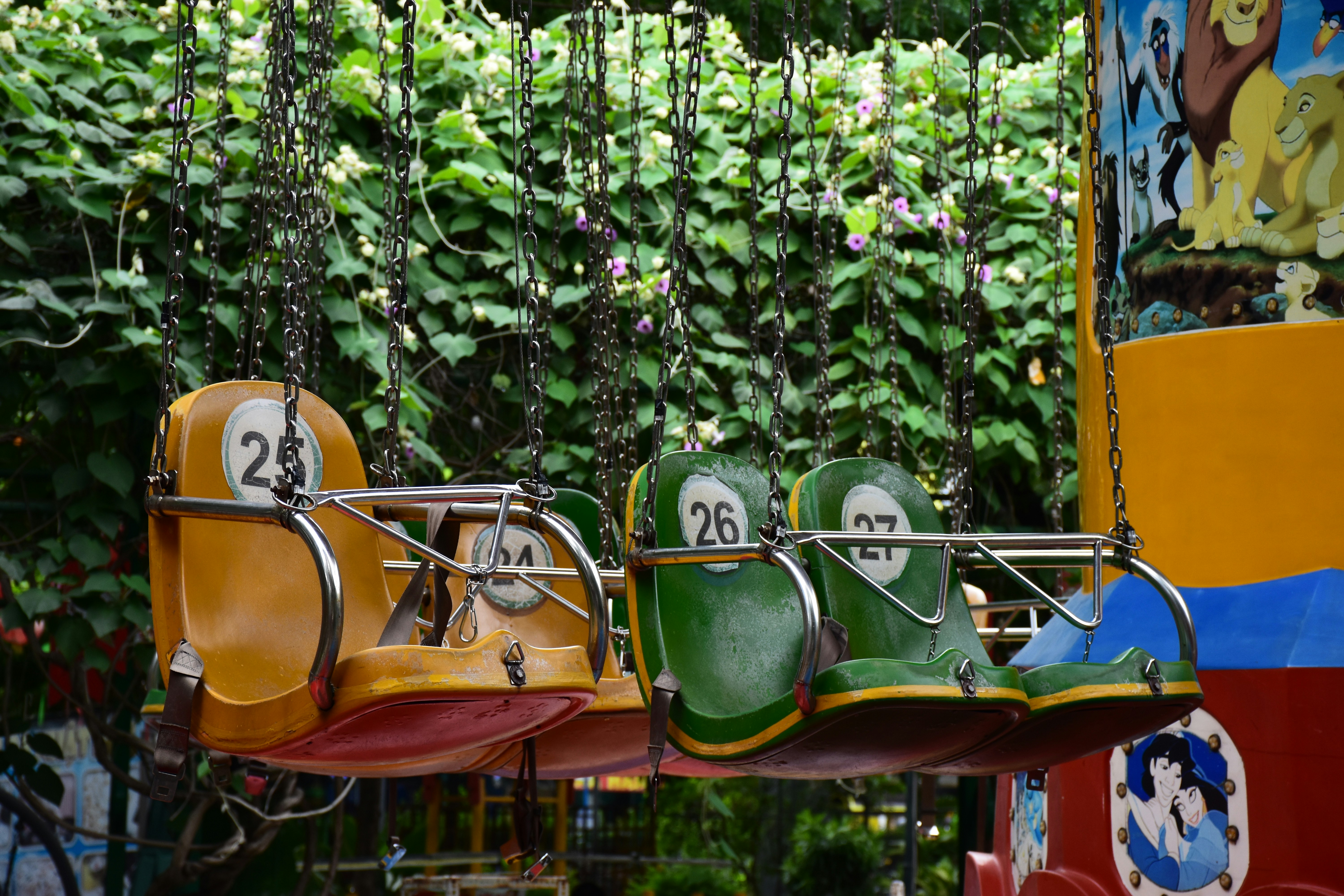 Center Seat 26: The Green Anchor in a Row of Colorful Carnival Swings