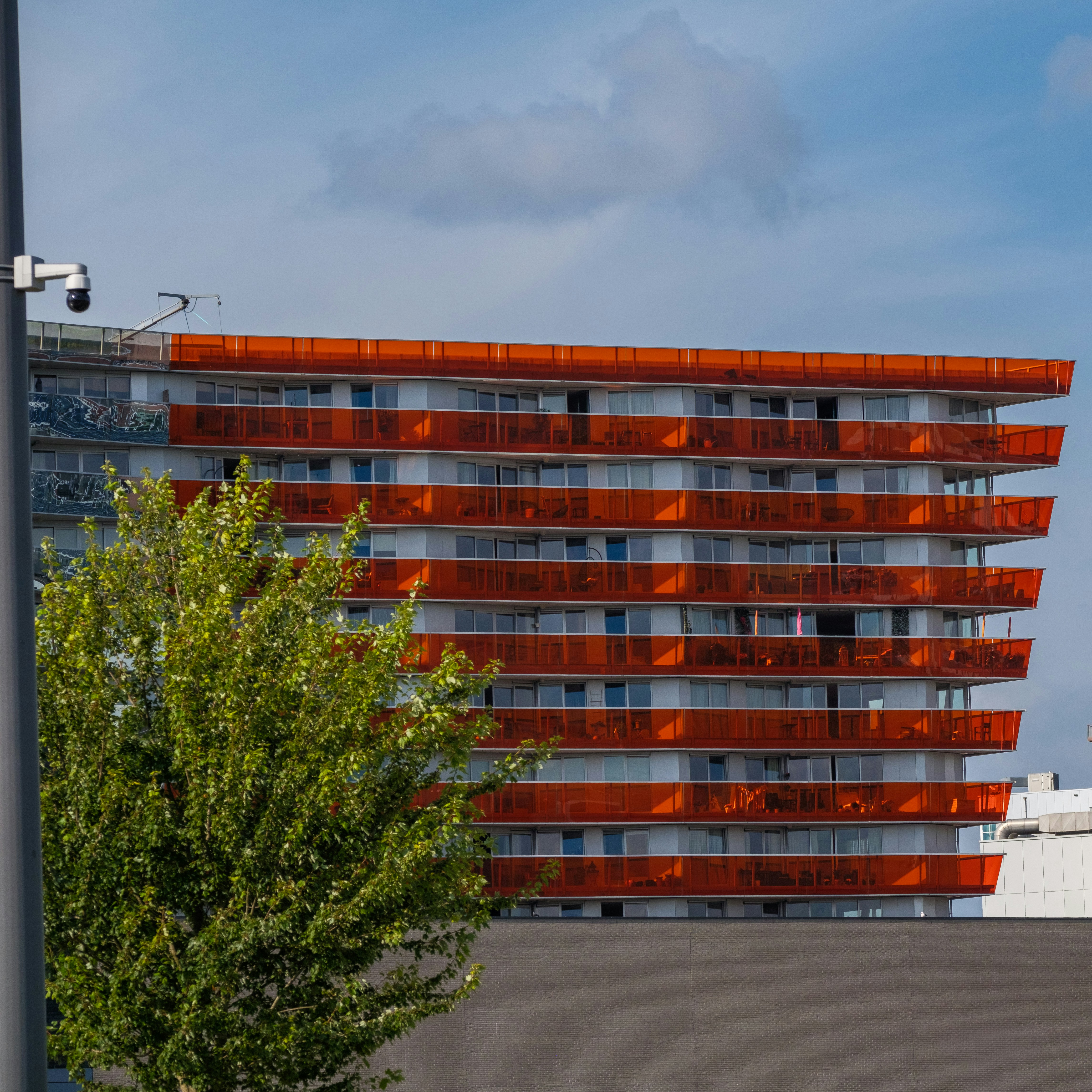 Red-angular Facade: A Horizontal Pyramid of Orange Glass