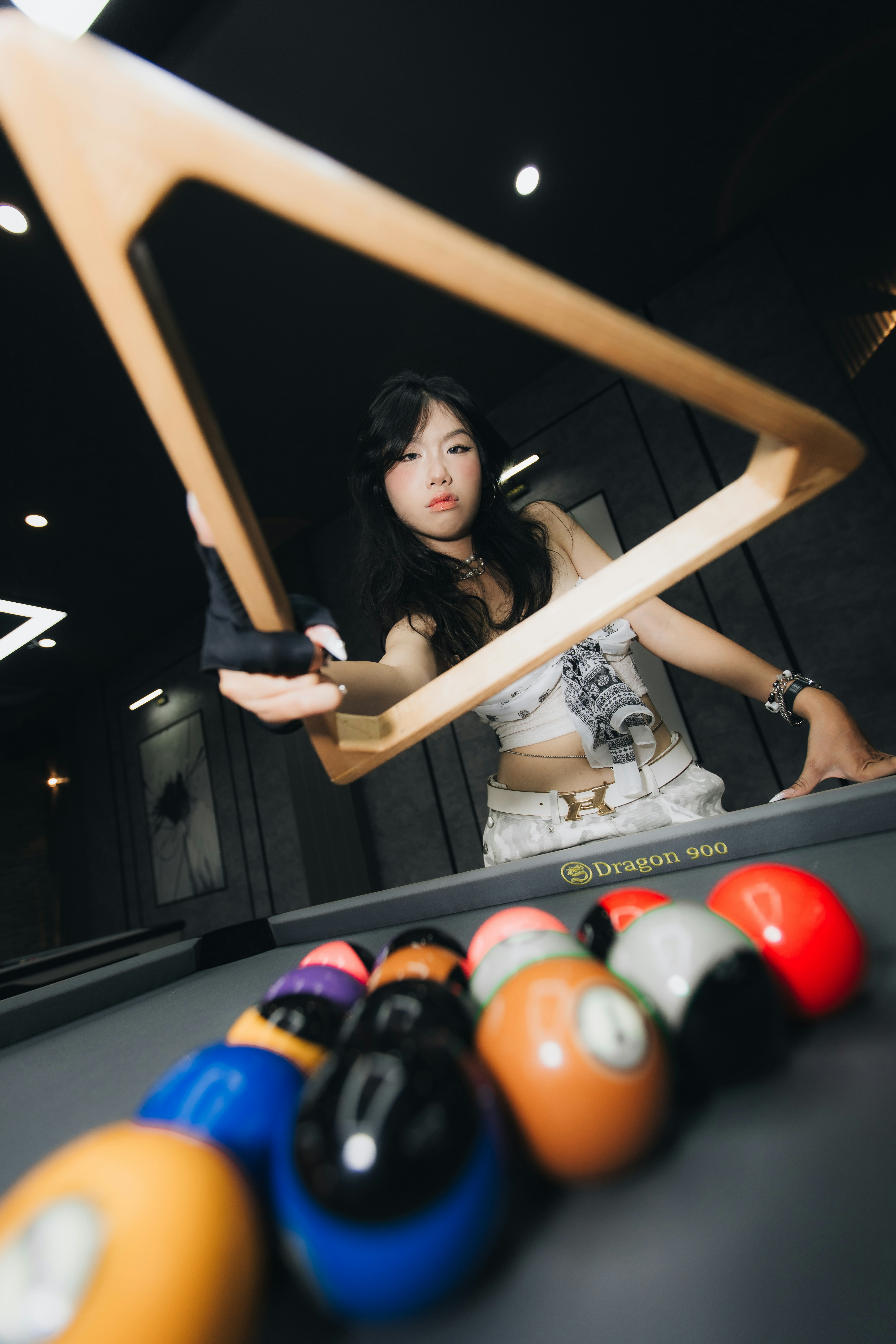 A woman playing a game of pool in a room