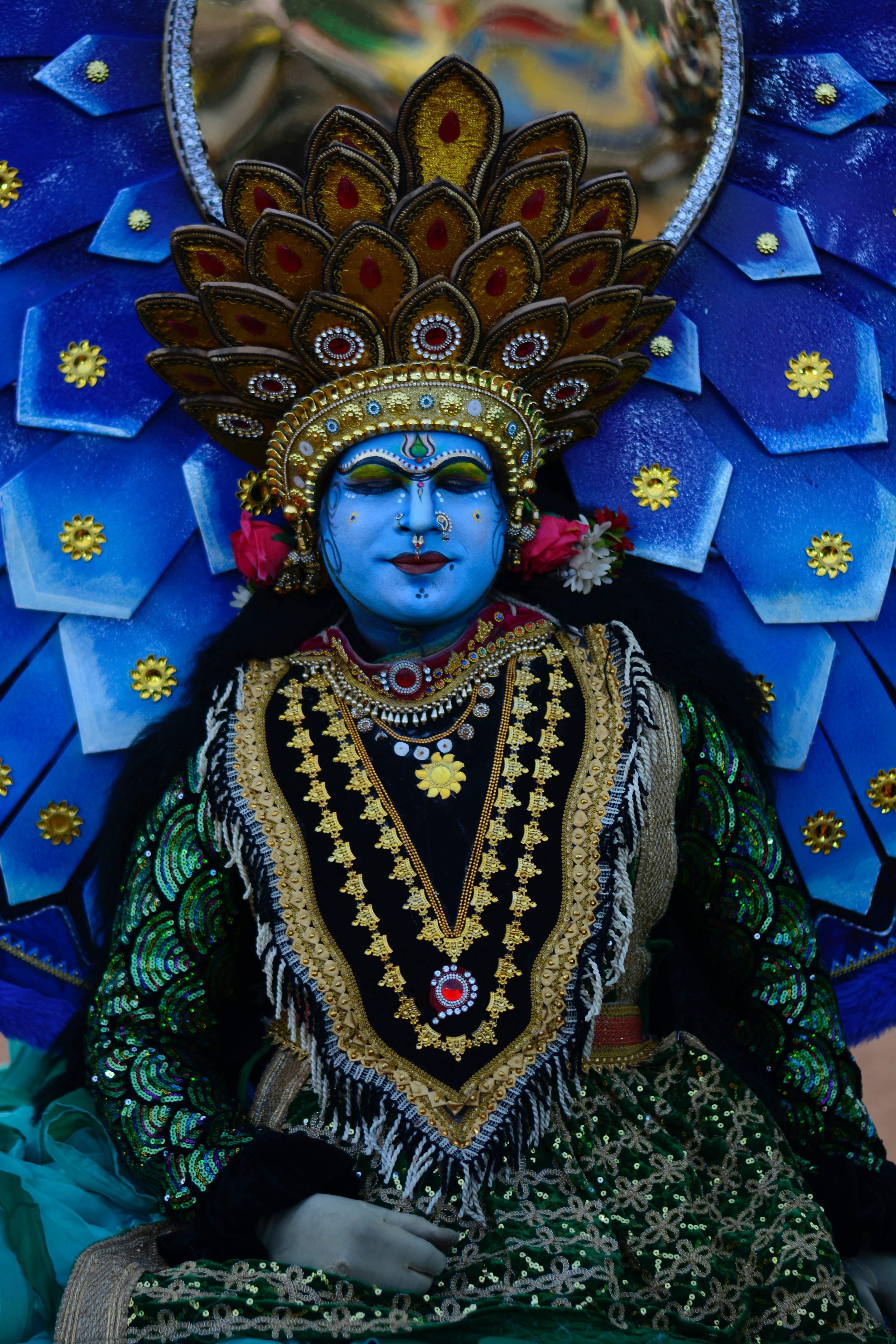 A statue of a woman sitting on top of a blue floor photo – Free Woman ...