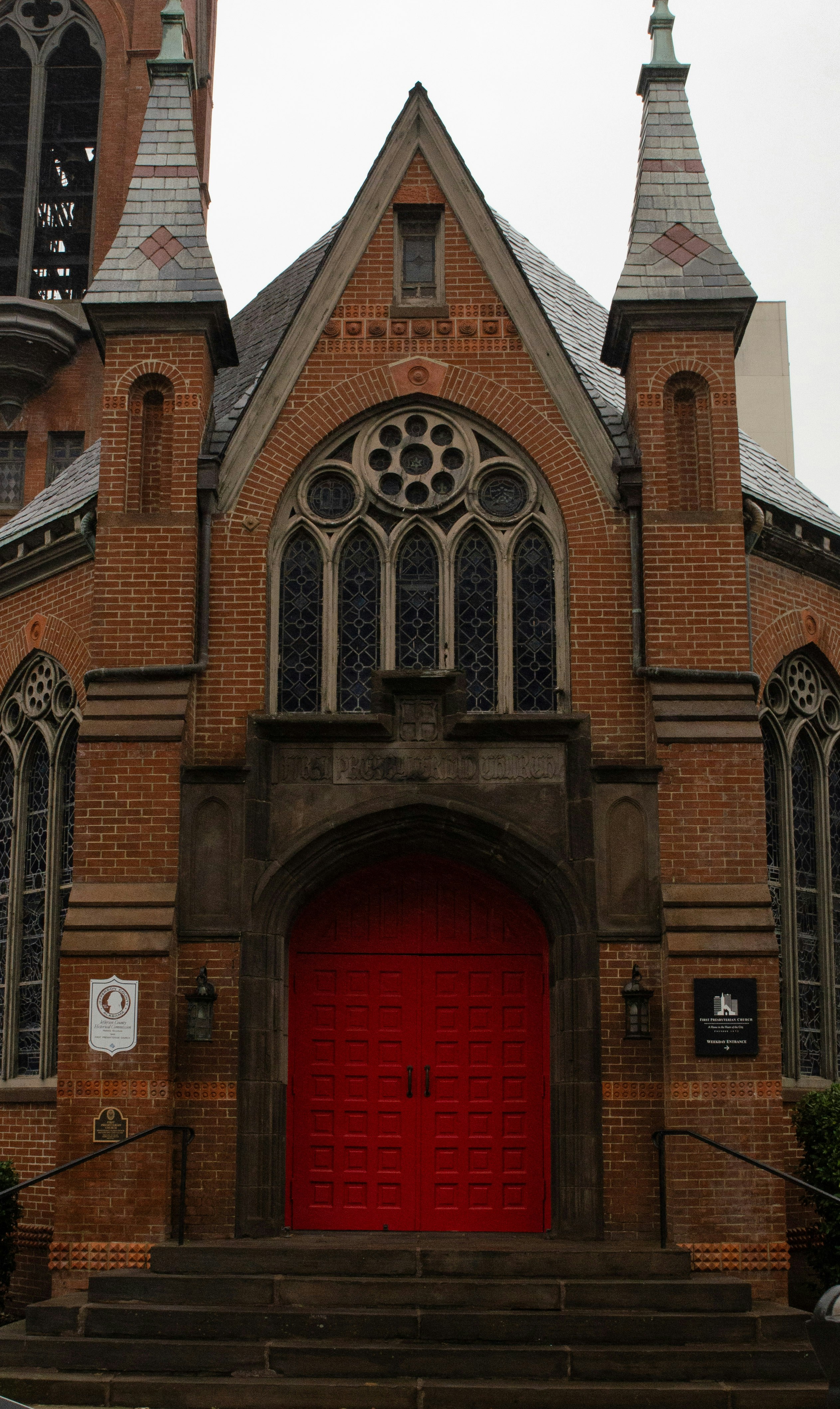 The Red Door Beneath Gothic Arches: A Brick-Church Facade
