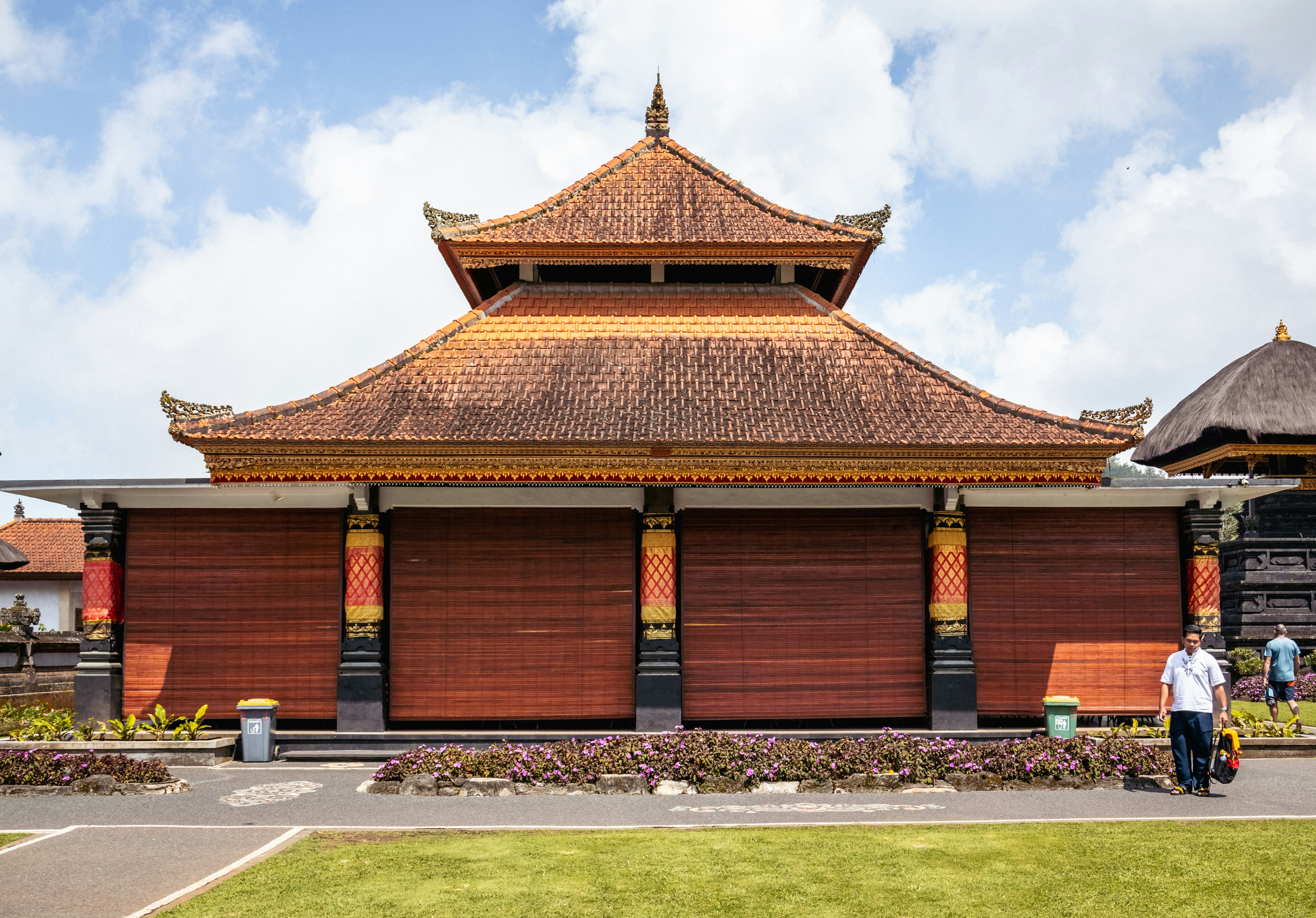 Three Gate Shutters Under a Blue Sky: A Red-Tiled Temple in Quiet Symmetry