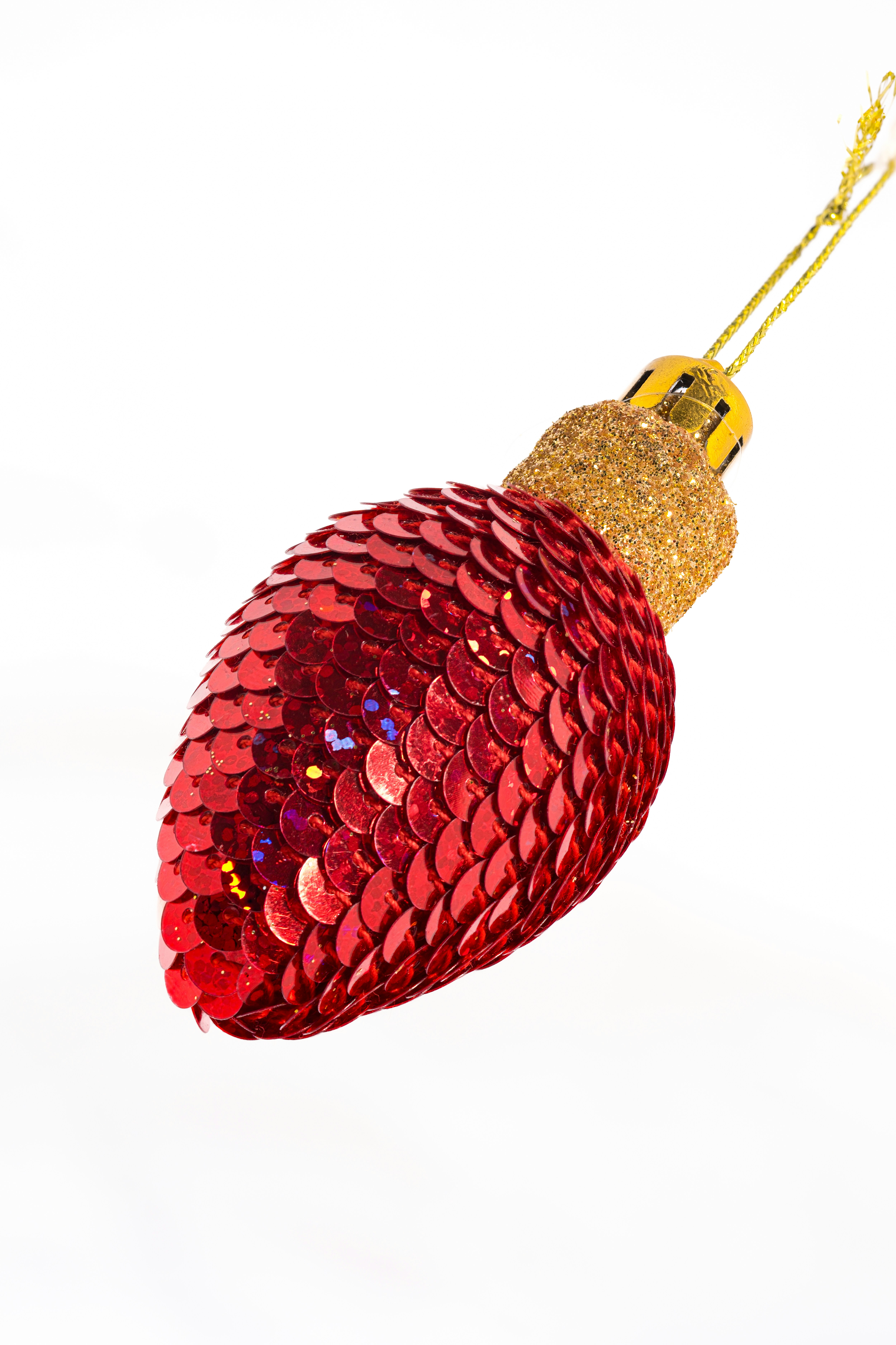 Tilted Crimson Sequined Ornament in a Pure White Studio