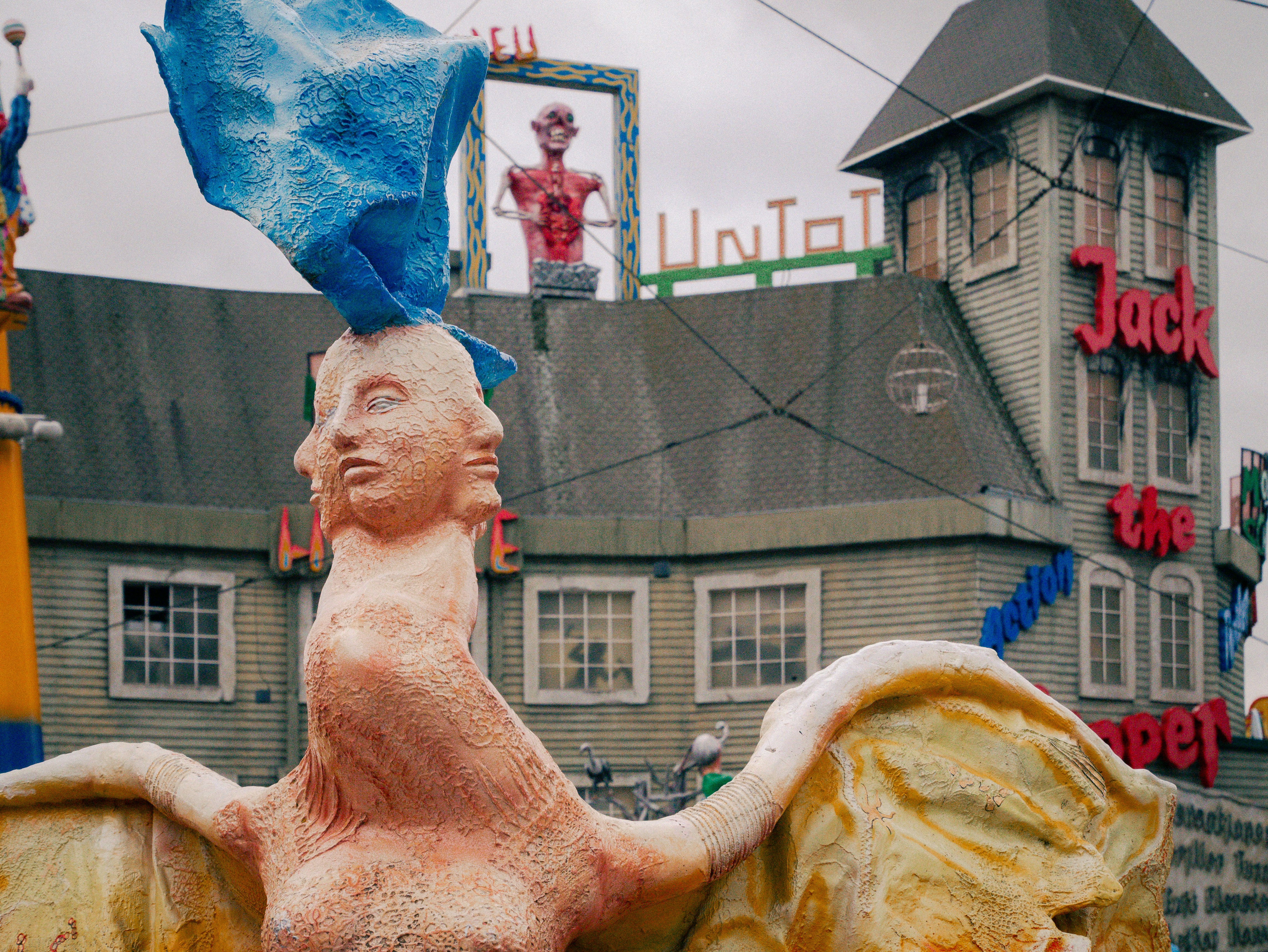 Whimsical Sculptures Guard a Facade of Oddities