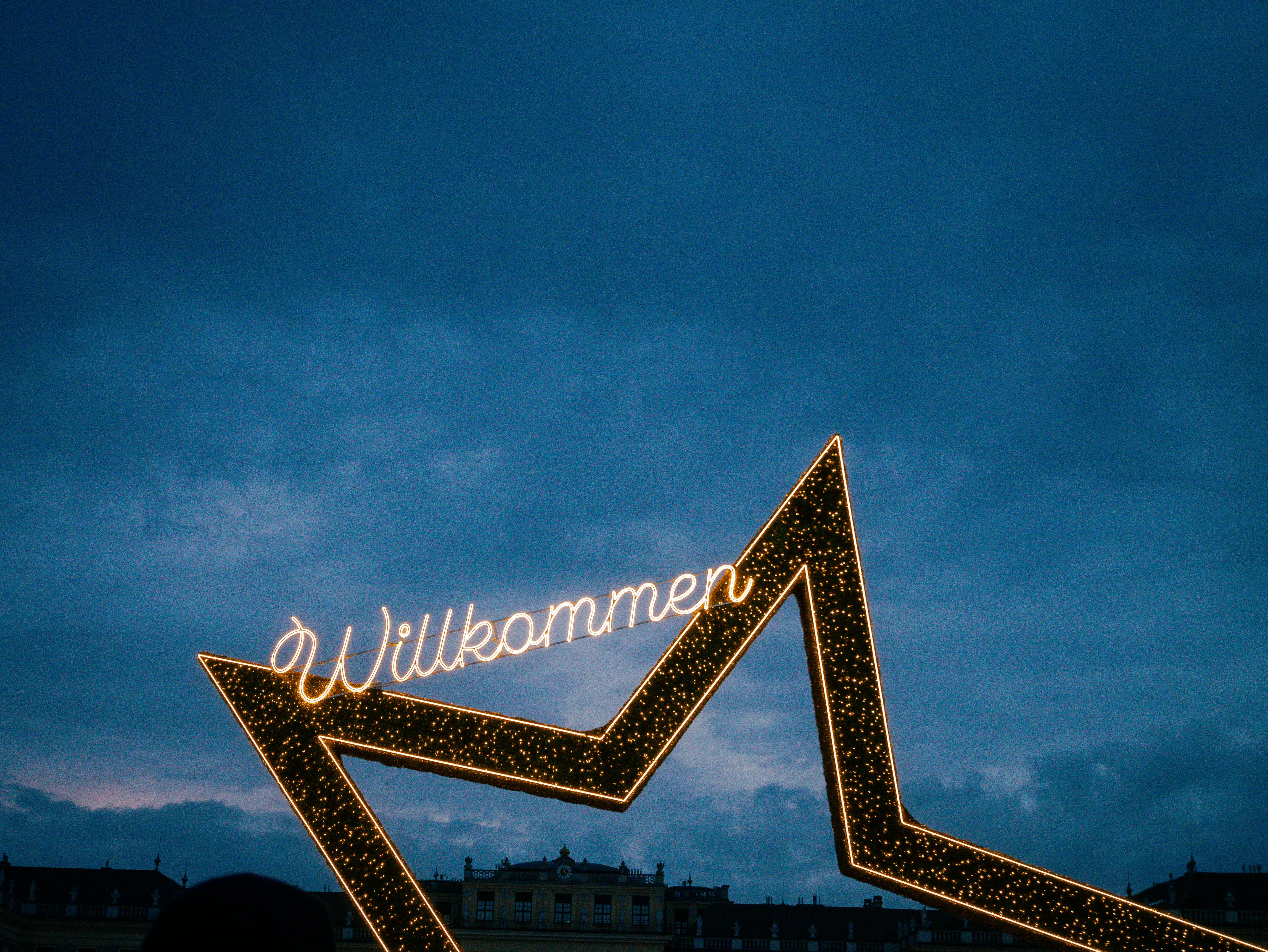 Neon Star Over a Dusky European Skyline
