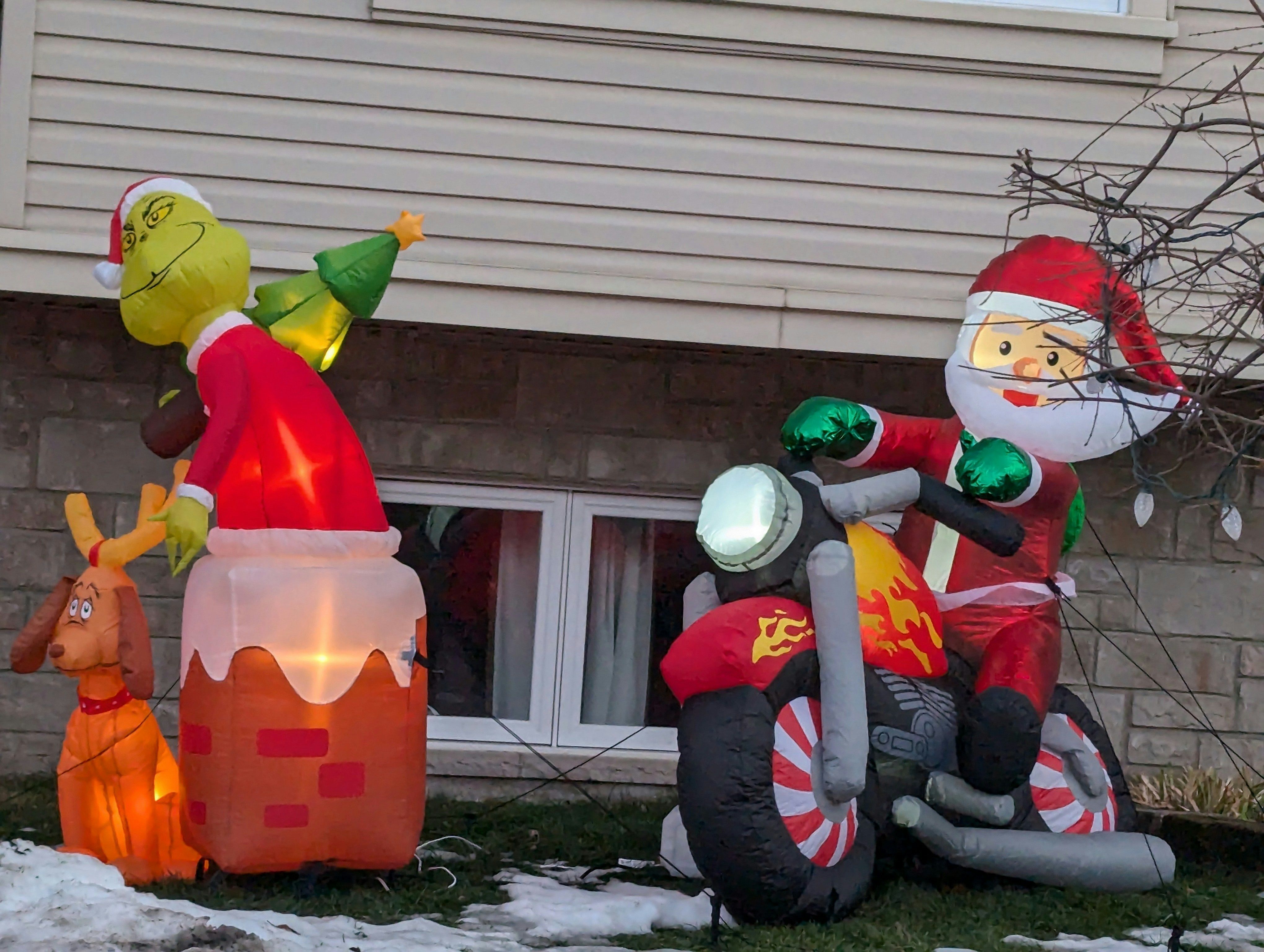 Pedal-Powered Santa on a Christmas Motorcycle in a Suburban Front Yard