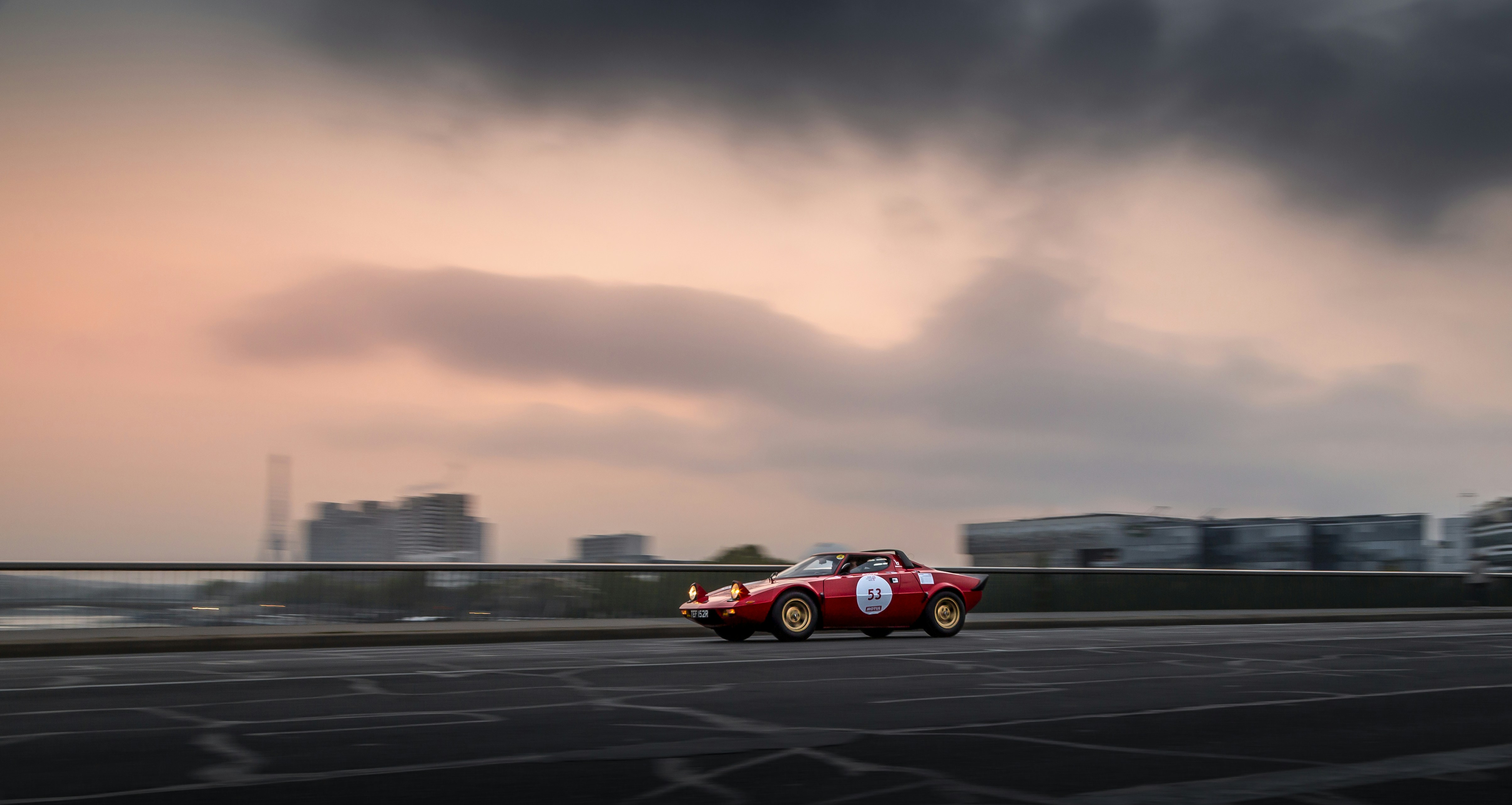 Crimson Racer on a Sunset Highway: A Deliberate Pan of Speed