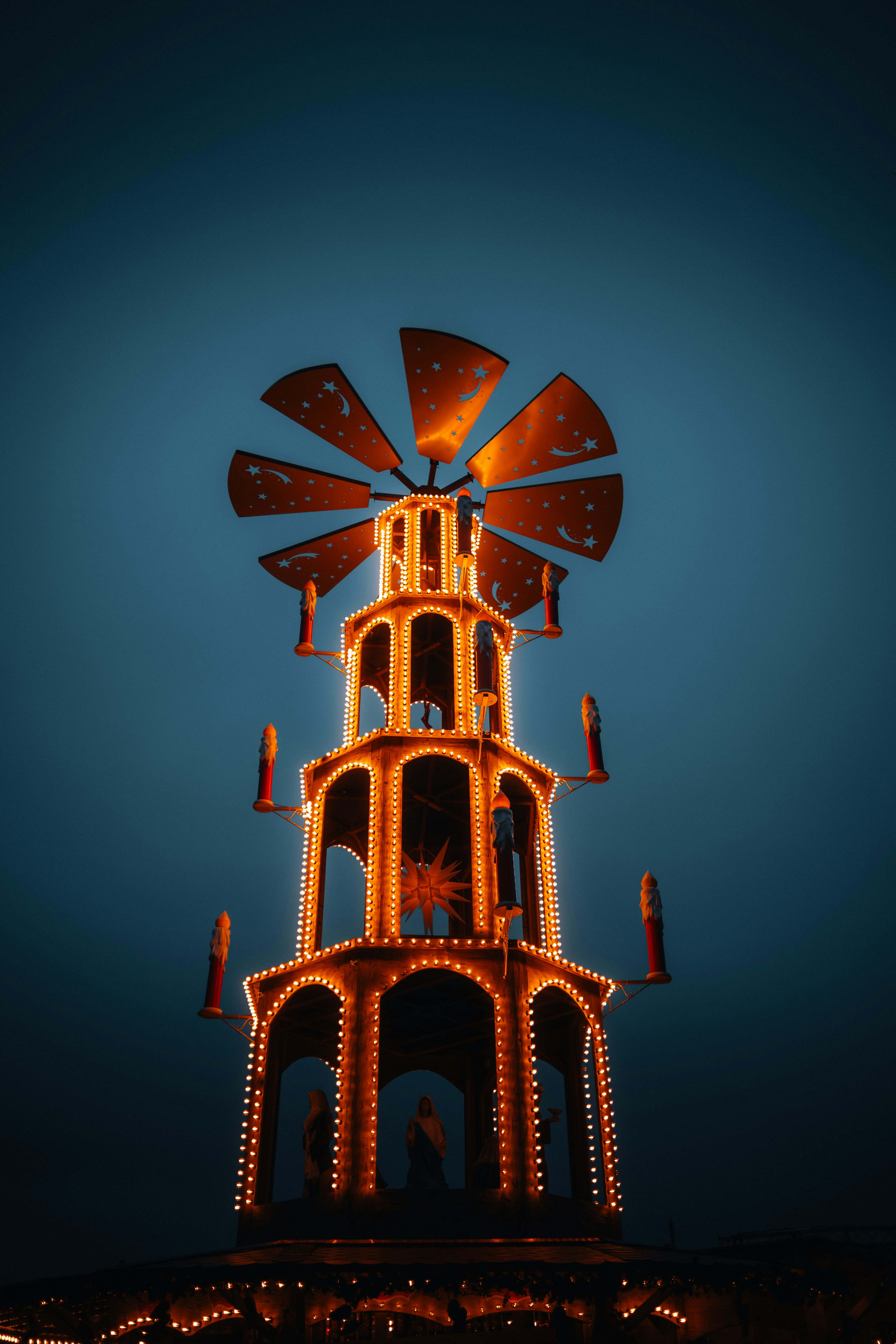 Amber-Lit Festive Tower: A Multilevel Lighted Beacon at Dusk