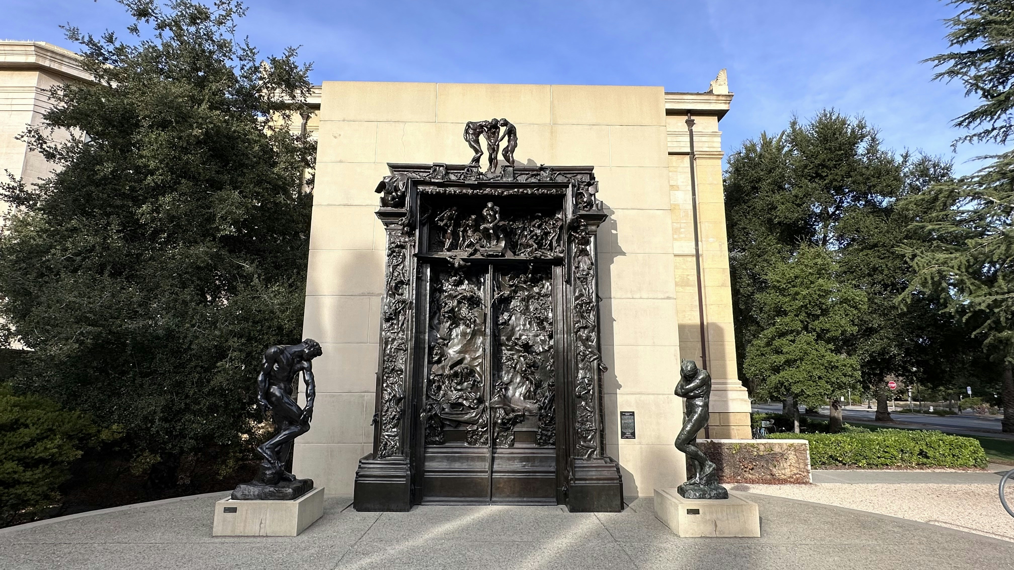 The Guardian Gate: Ornate doors and sculpted statues at a museum entrance