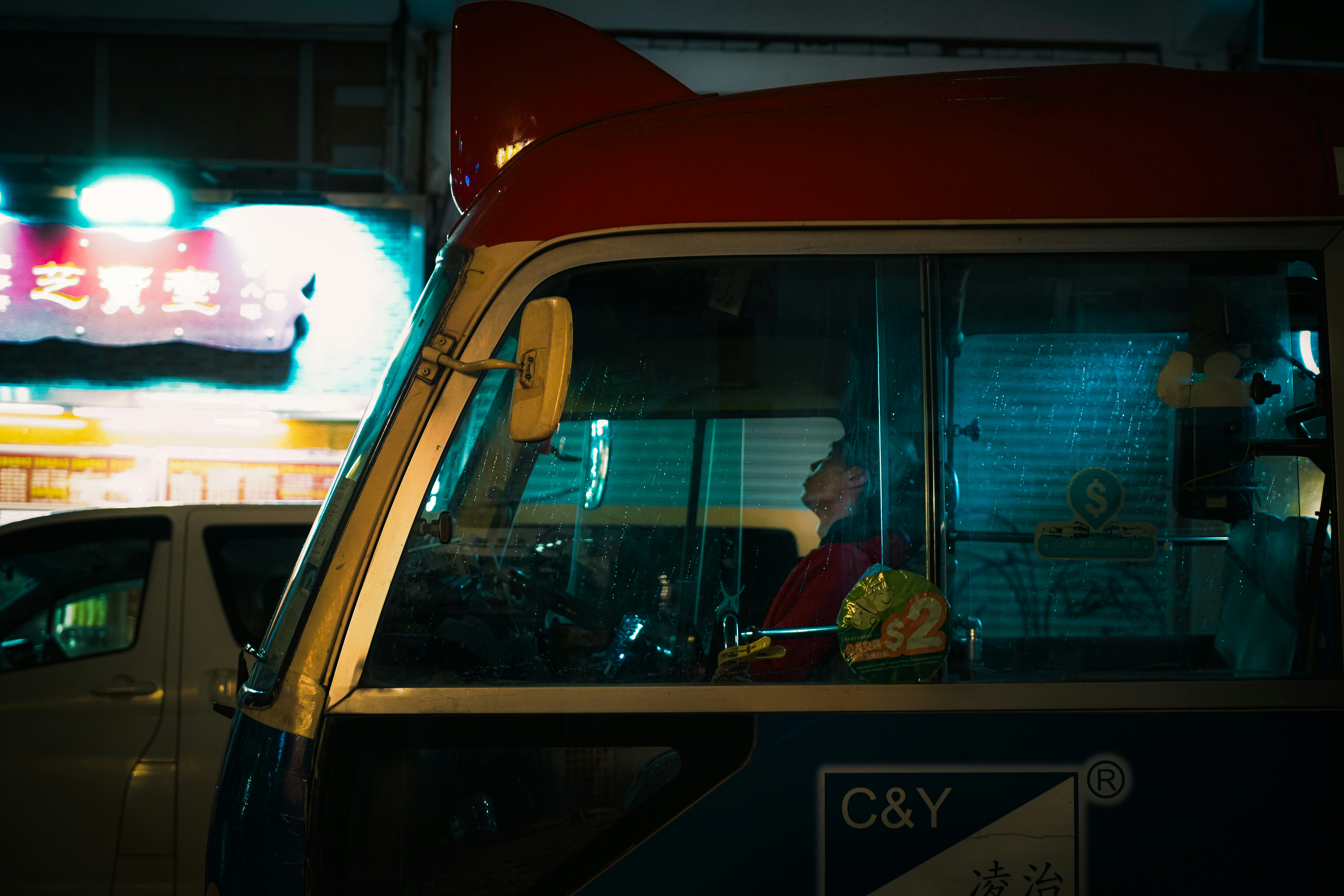 A man sitting in the back of a truck at night photo – Free Hong kong ...
