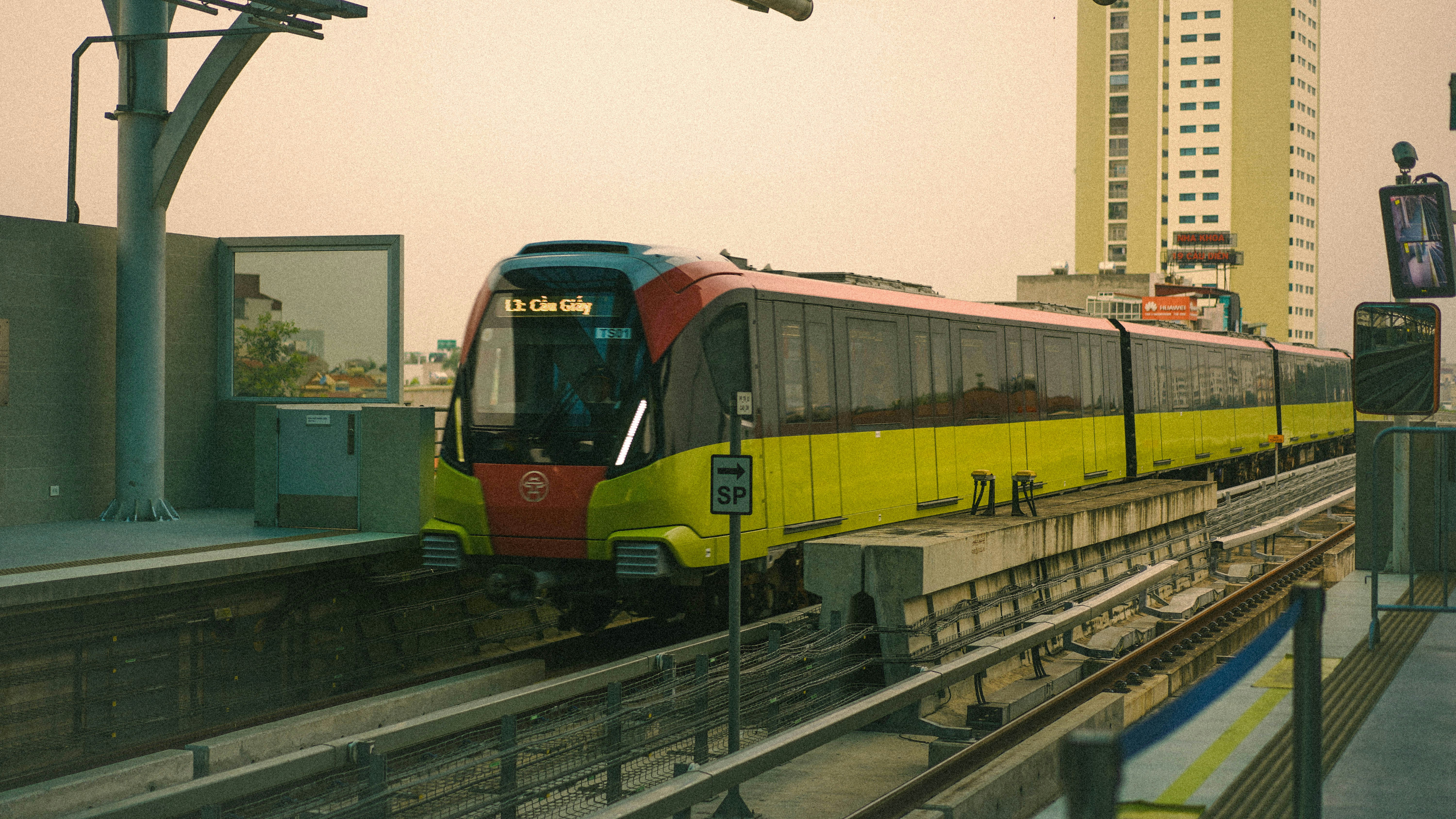 Front-Nose of a Yellow-Green Tram Anchors a Quiet Urban Platform