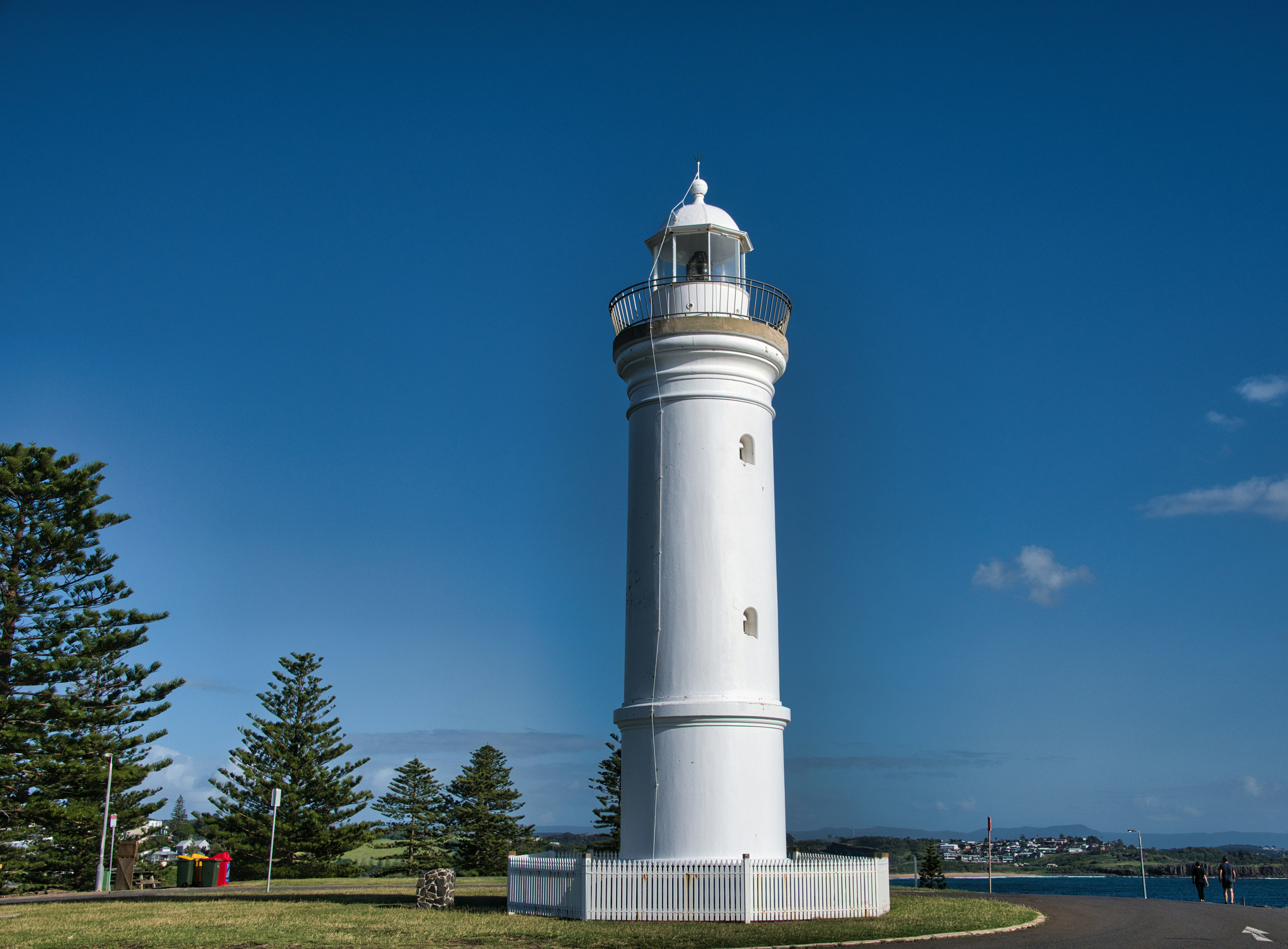 Cerulean Sky, White Beacon: A Coastline Lighthouse in Crisp Daylight